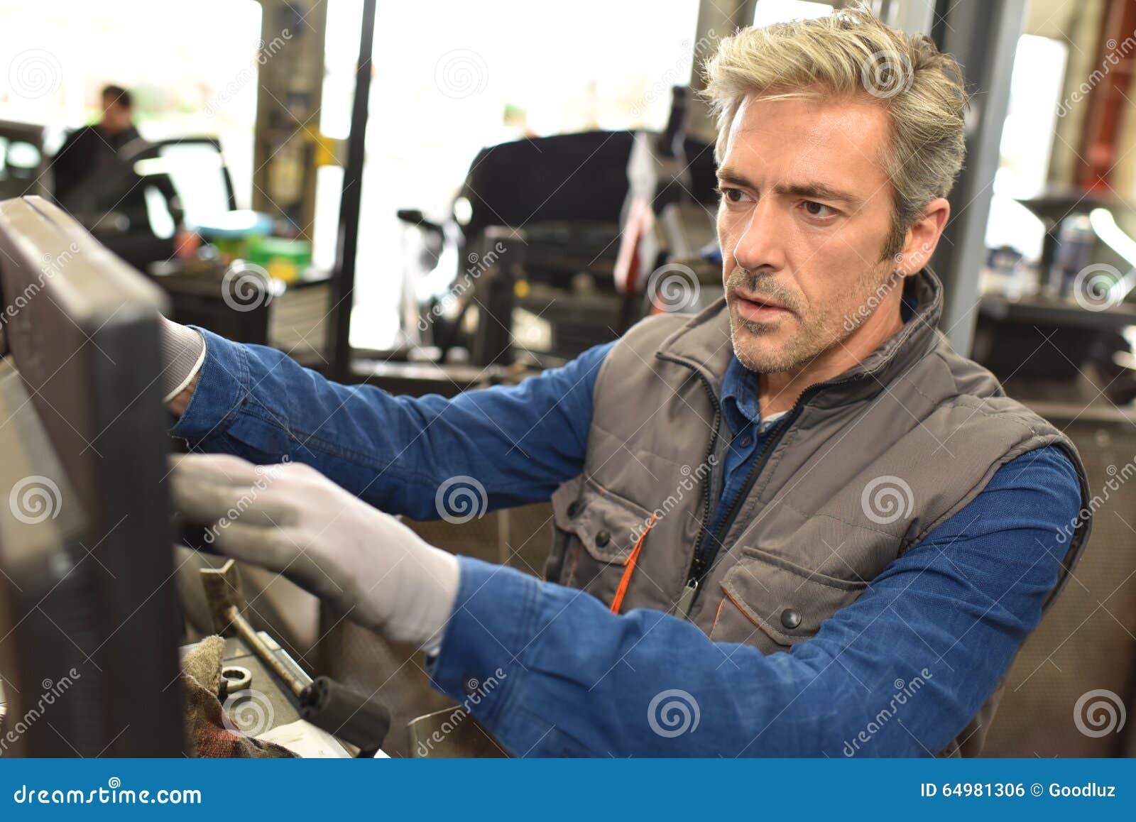 Mechanical Worker Setting Up Machines in Car Workshop Stock Photo ...