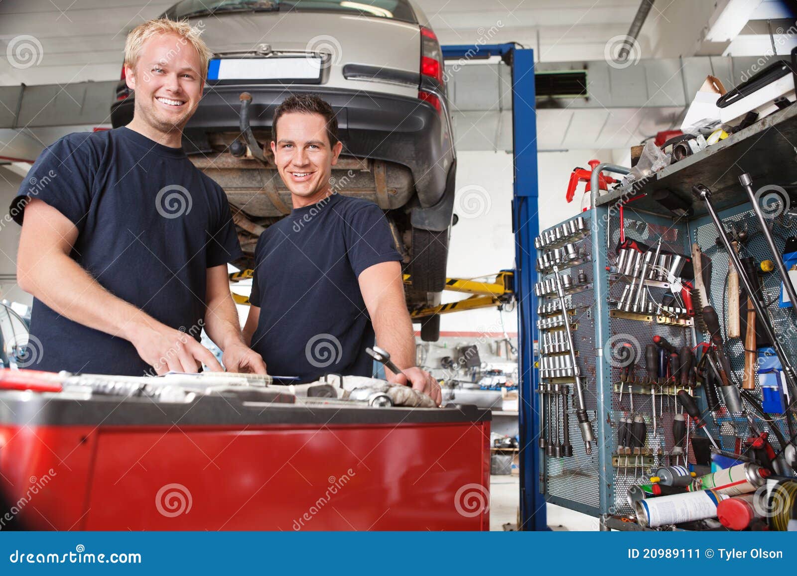 Mechanics at an auto shop stock image. Image of repair - 20989111