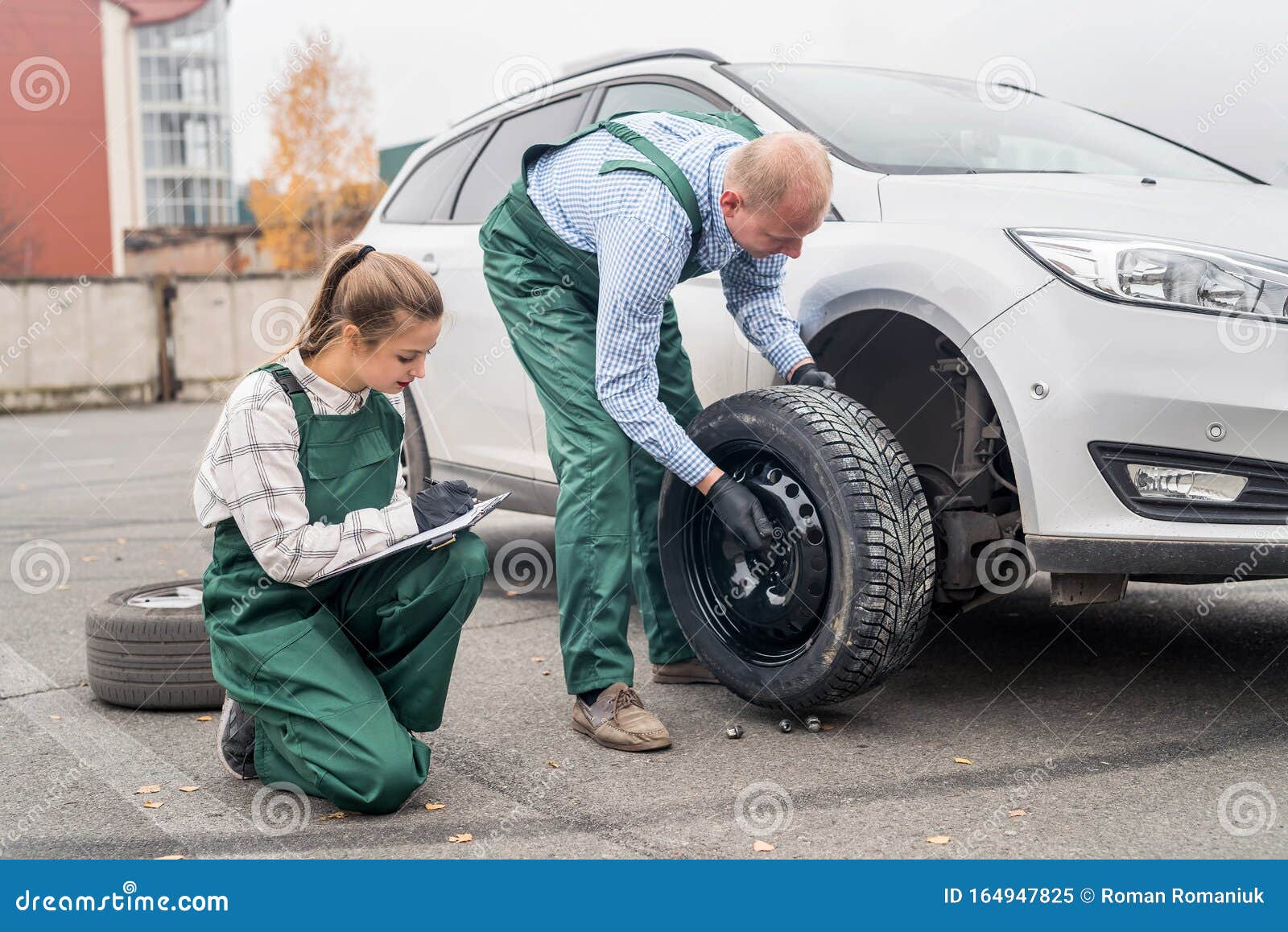 Mechanics Changing Wheel of a Car at Service Stock Image - Image of ...