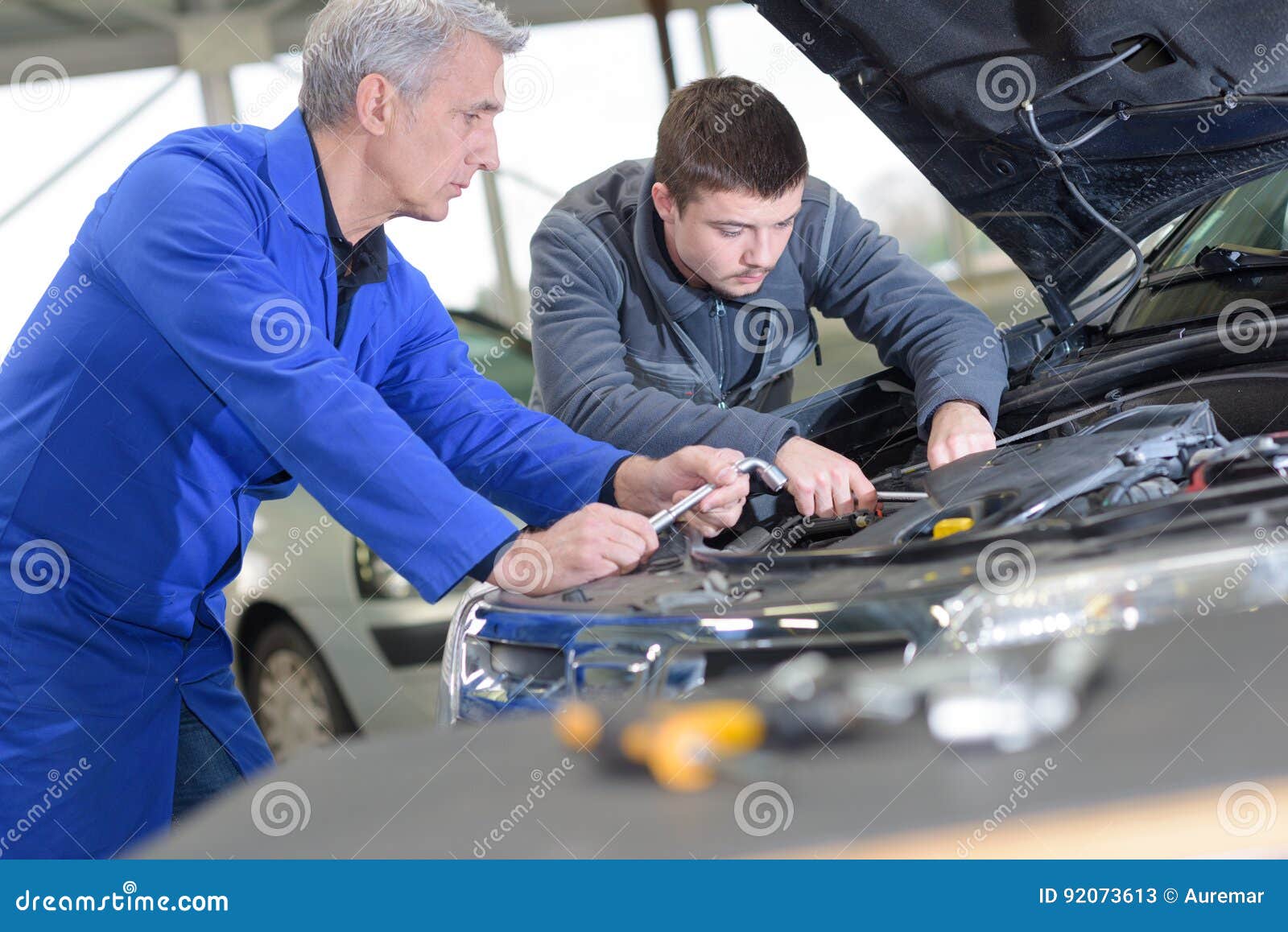 Mechanics Leaning on Car in Garage Stock Image - Image of technician ...
