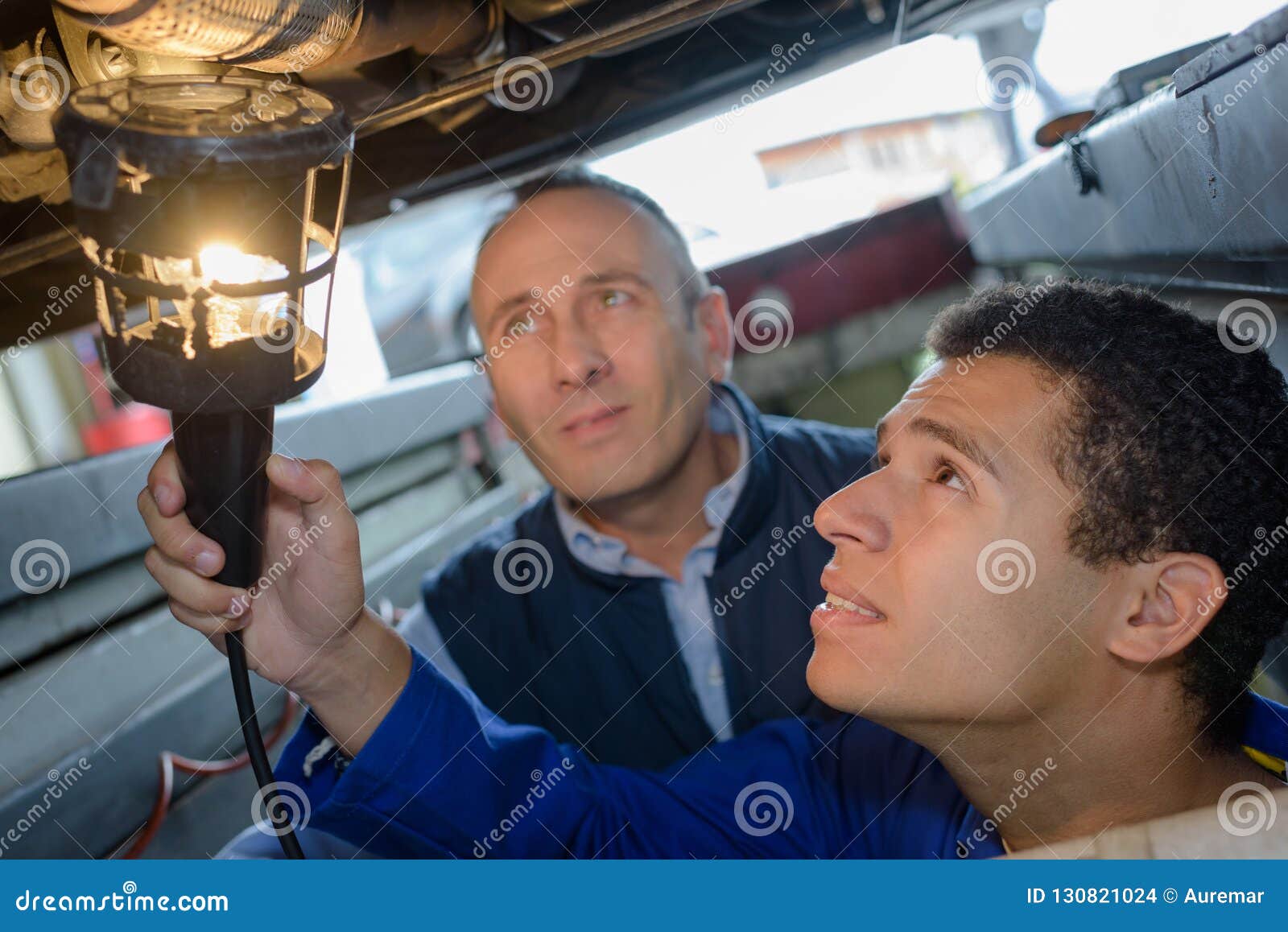 Mechanics Using Torch To Look Under Car At Repair Garage Stock Photo ...