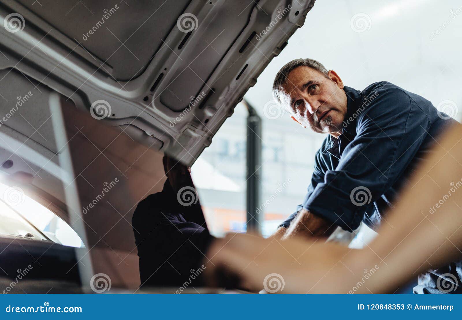 Mechanics Working on a Broken Car in Garage Stock Image - Image of ...