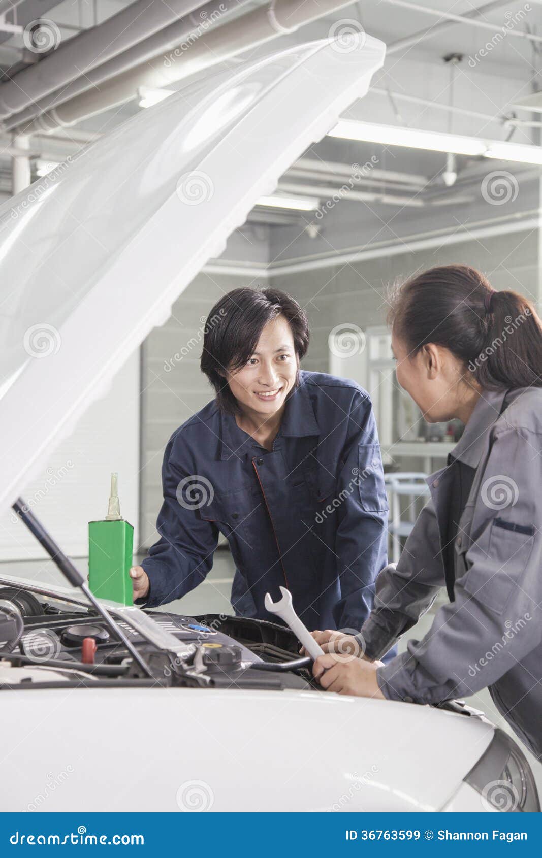 Mechanics Working on Car in Auto Repair Shop Stock Image - Image of ...