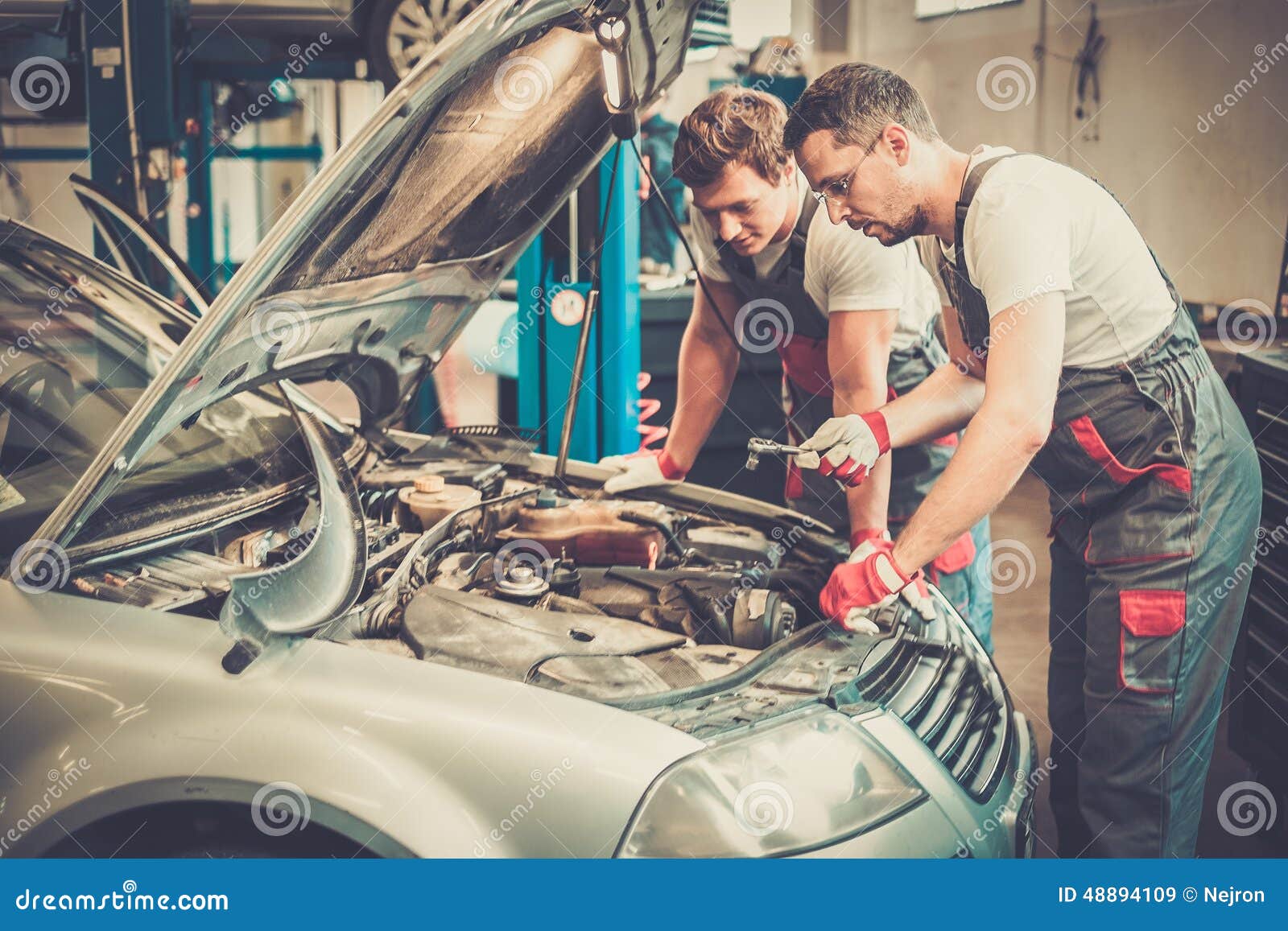 Mechanics in a workshop stock image. Image of official - 48894109