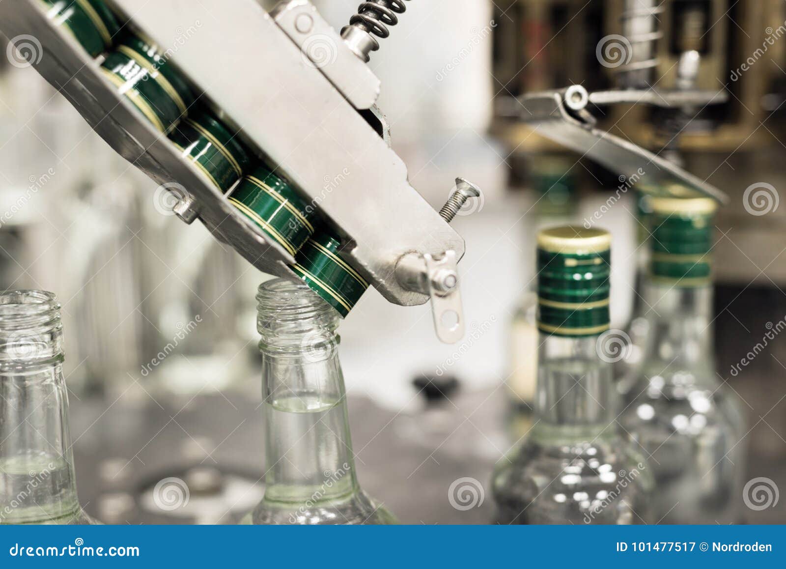 The Mechanism of the Automatic Bottle Capping Machine. Stock Image ...