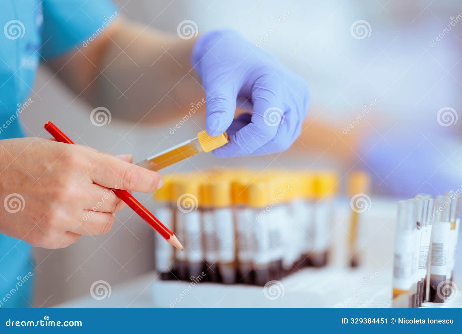 Medical Assistant Holding Blood Sample in a Laboratory for Testing ...