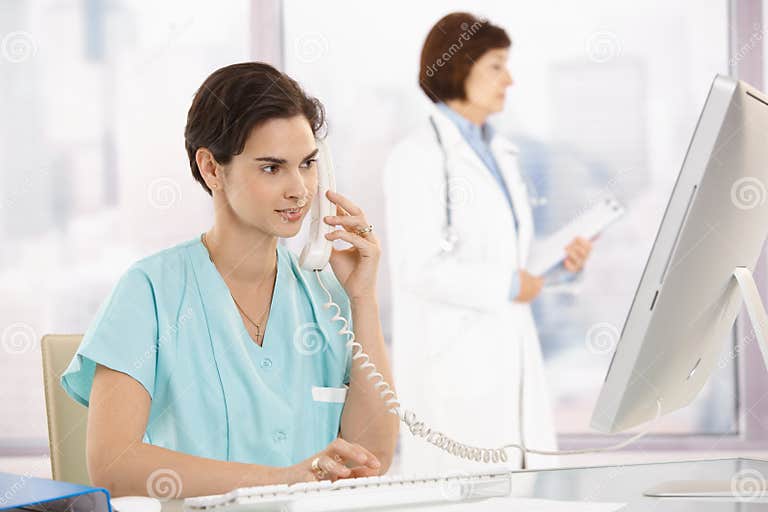 Medical Assistant on Phone, Using Computer Stock Photo - Image of ...