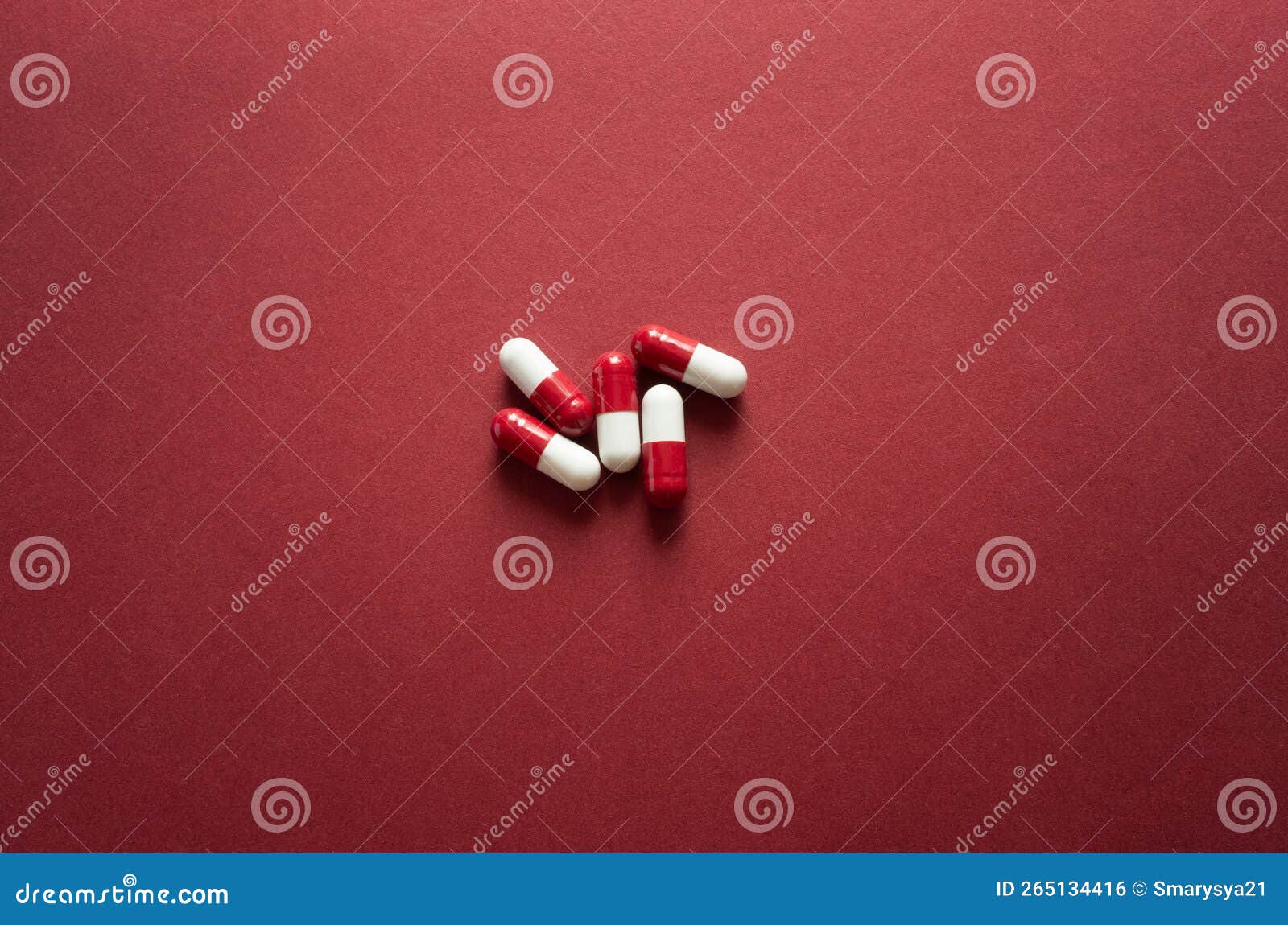 Medical Background, Red-white Capsules on a Red Background. Top View of ...