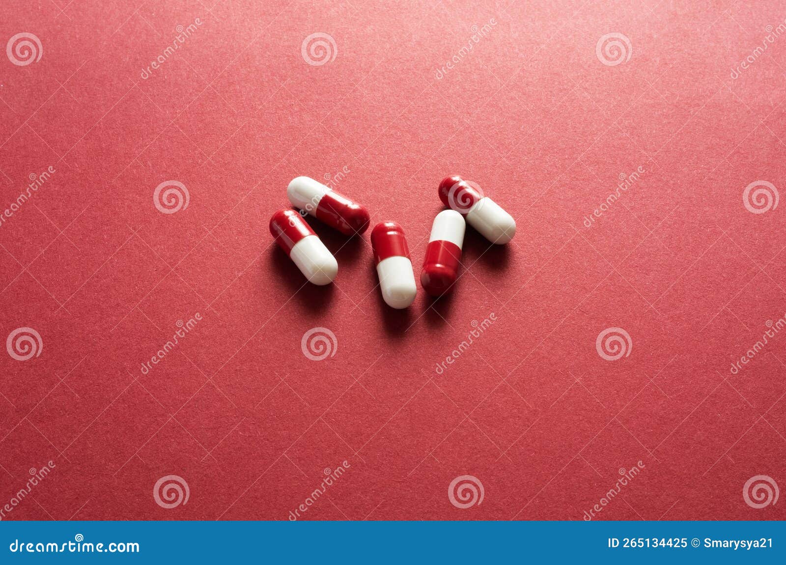Medical Background, Red-white Capsules on a Red Background. Top View of ...