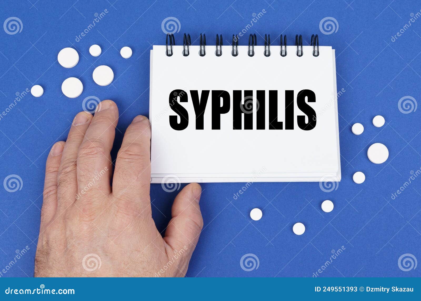 On the Blue Surface of the Tablet, a Hand and a Notepad with the ...