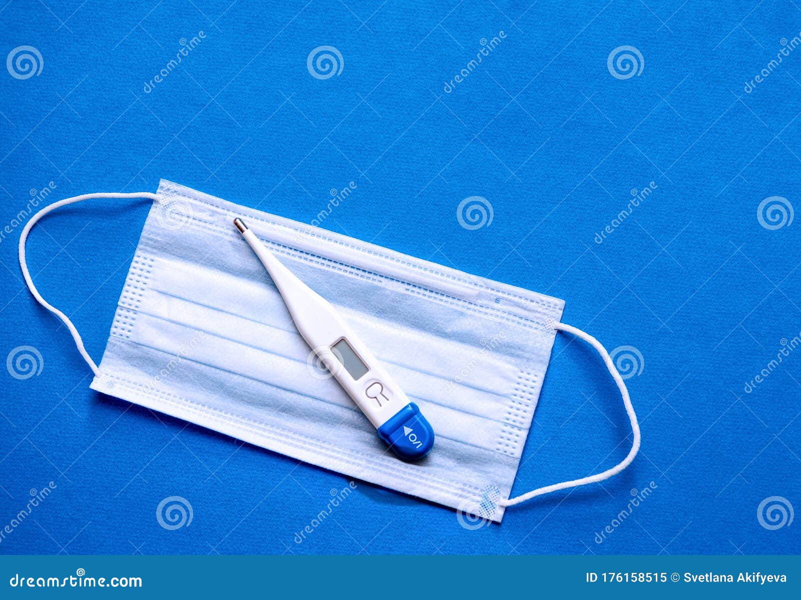 Medical Digital Thermometer And Medical Mask On A Blue Background ...