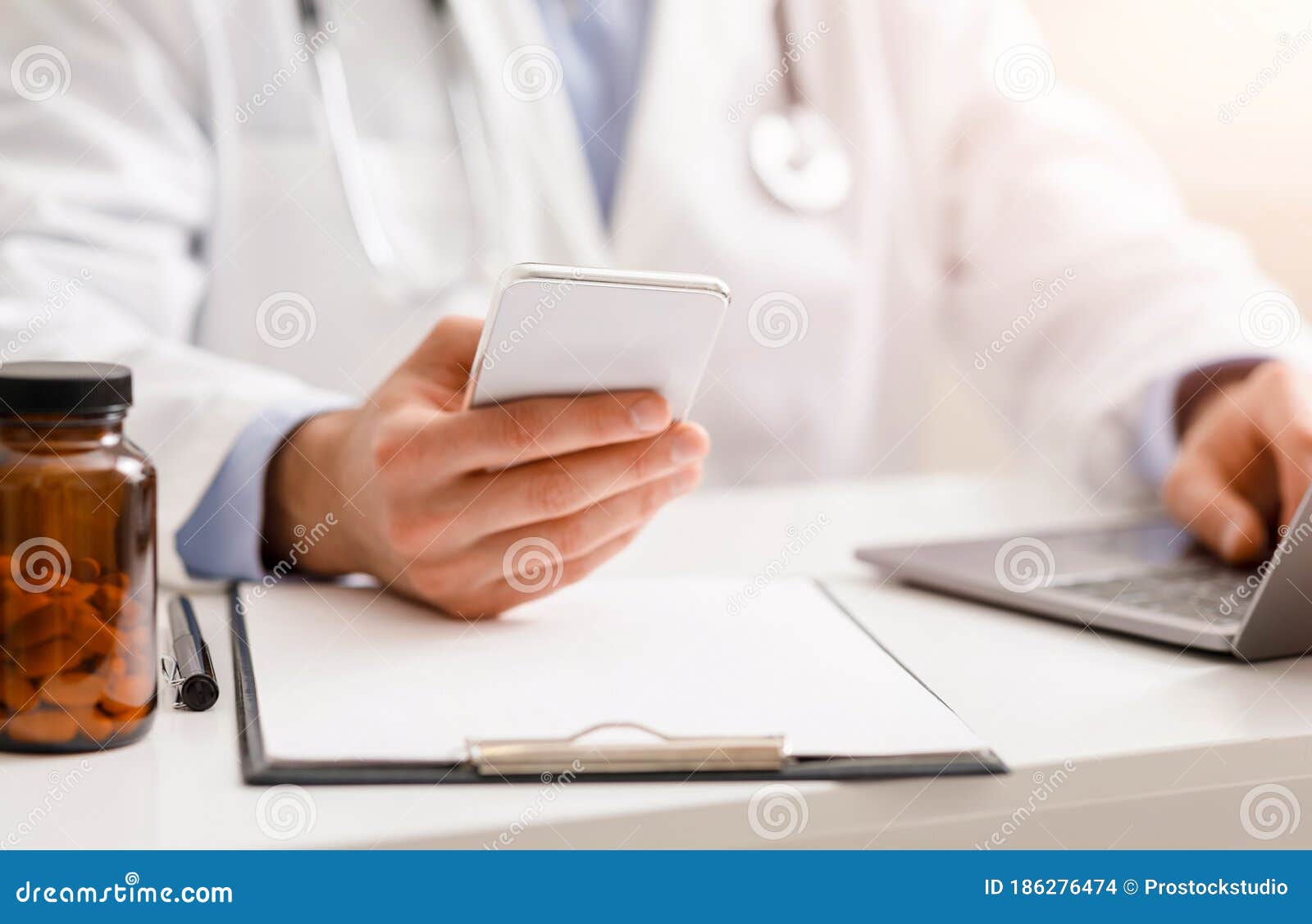 Medical Doctor Using His Cellphone in Office Stock Photo - Image of ...