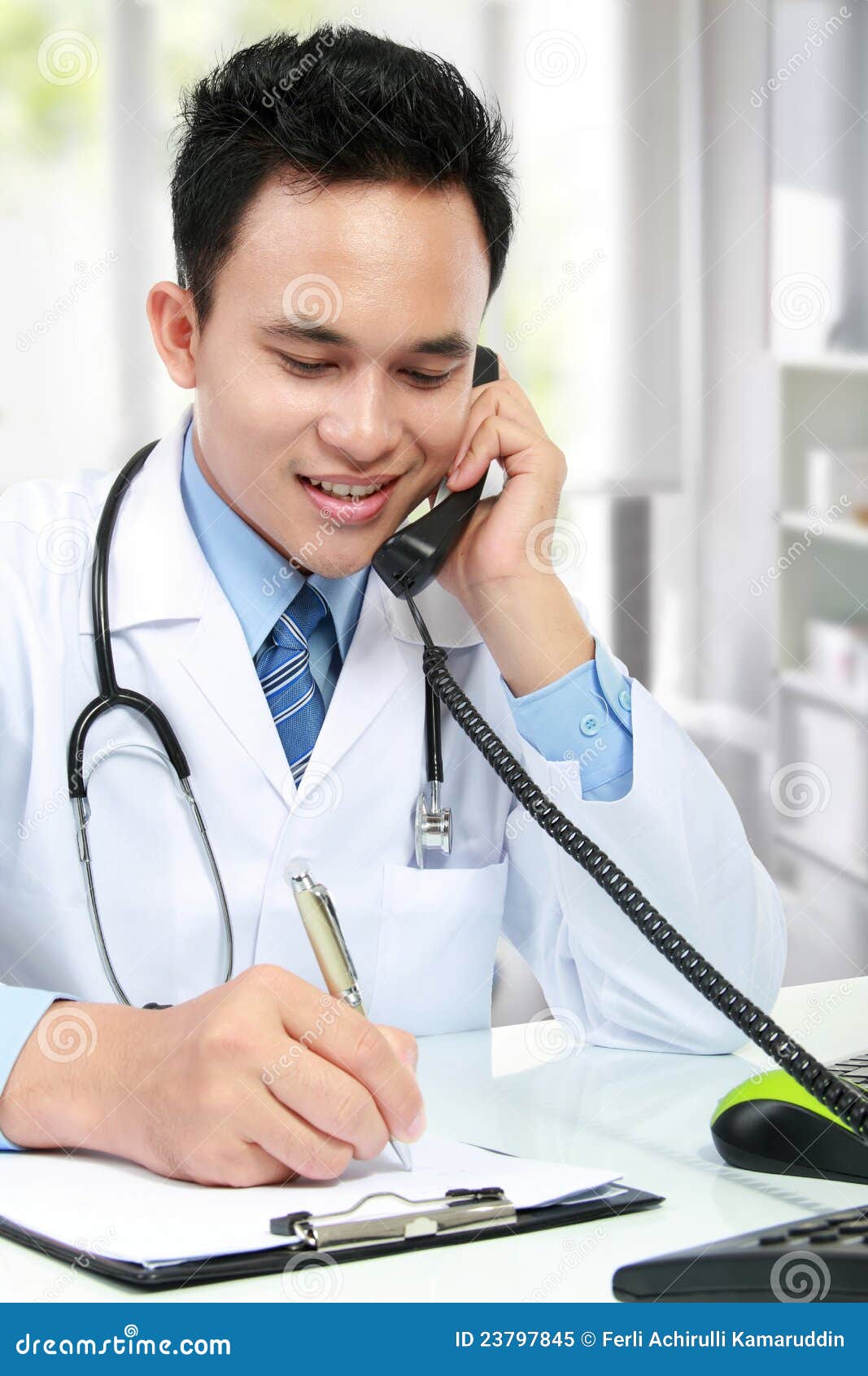 Medical Doctor Writing a Note while Calling Stock Image - Image of ...