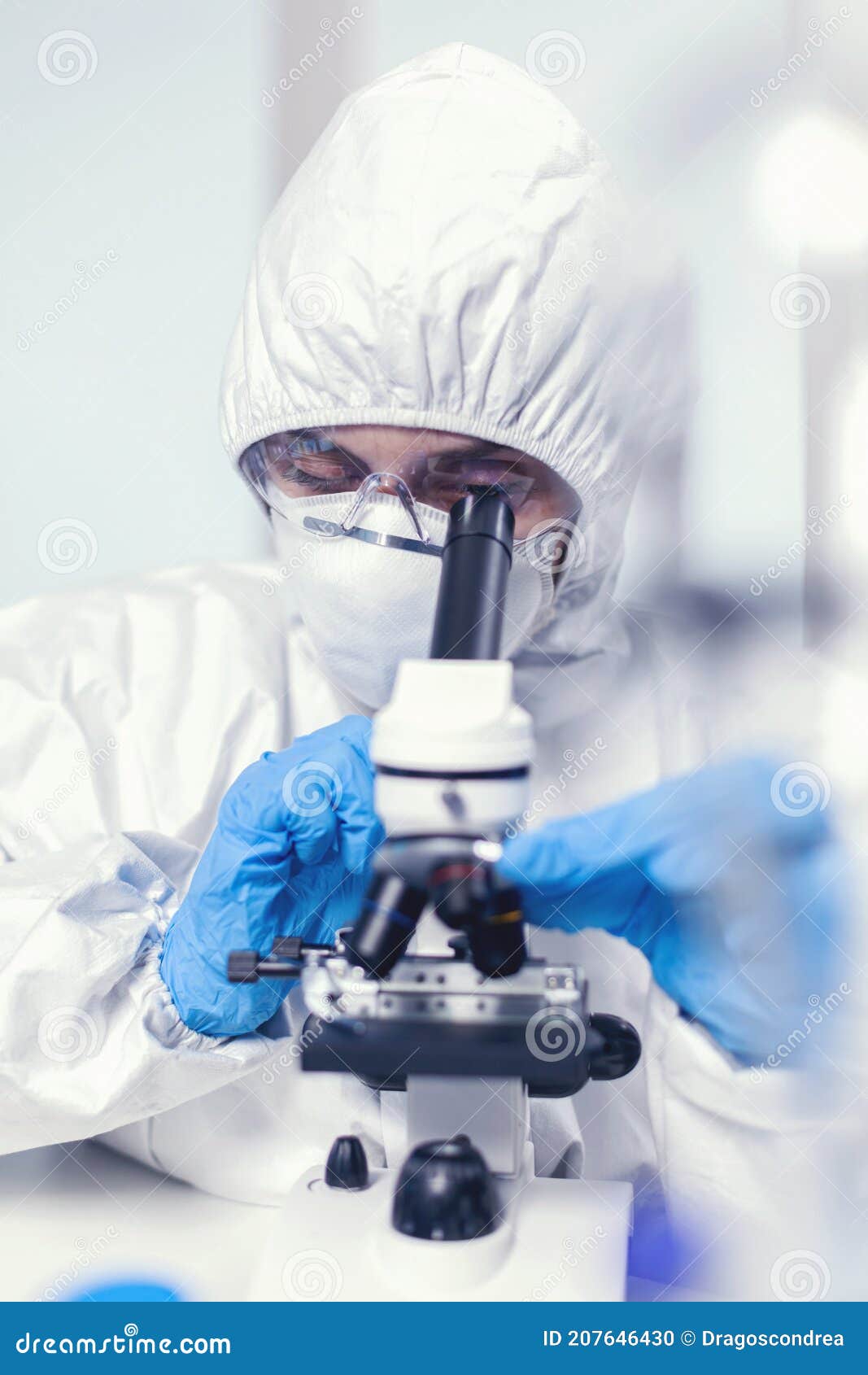 Medical Engineer in Ppe Suit in Modern Laboratory Looking at Sample ...