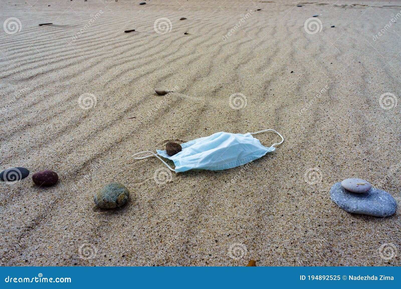 Medical Mask on the Sand, Protective Fabric Mask on the Sea Beach Stock ...