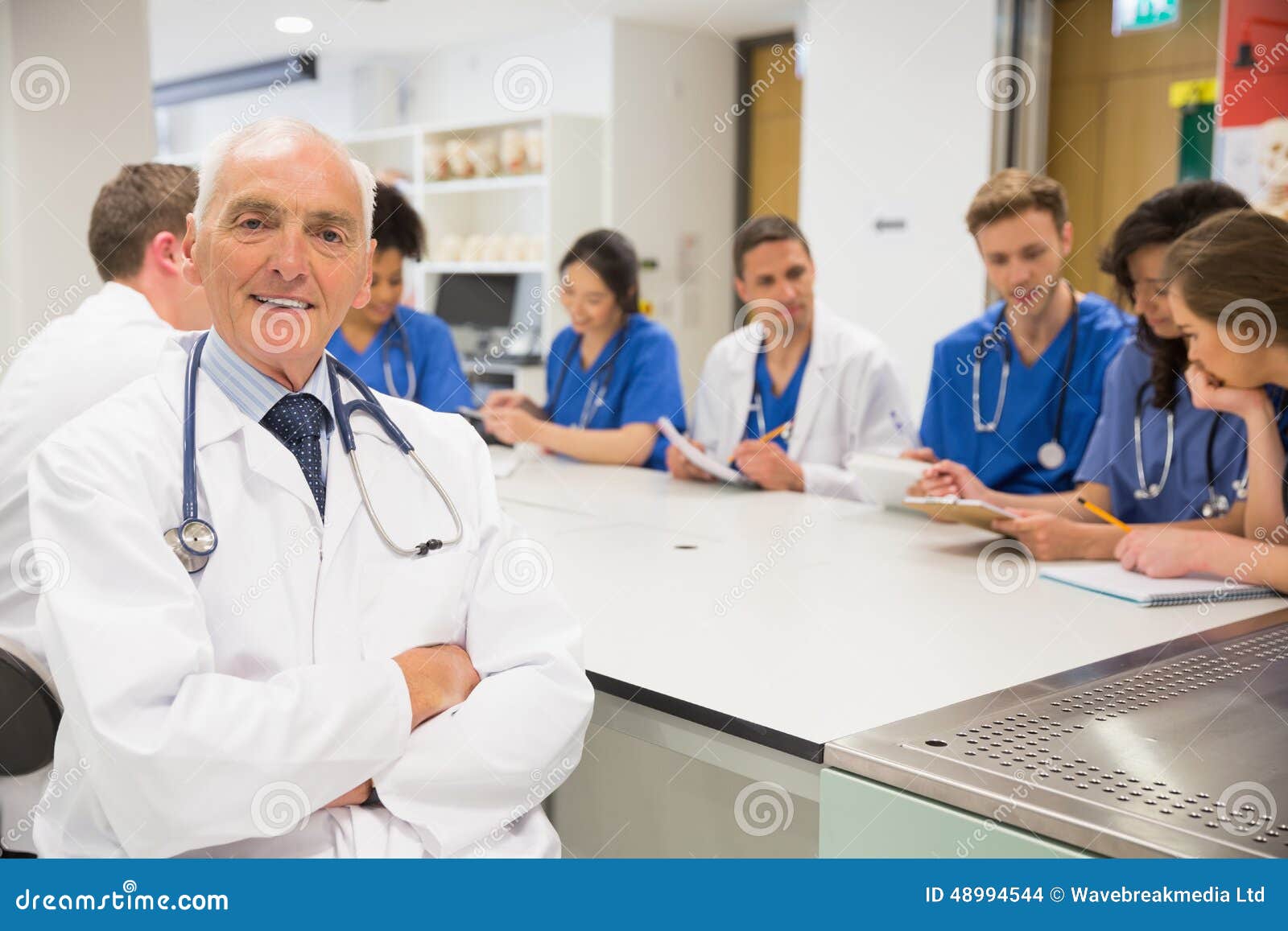 Medical Professor Smiling at the Camera during Class Stock Photo ...