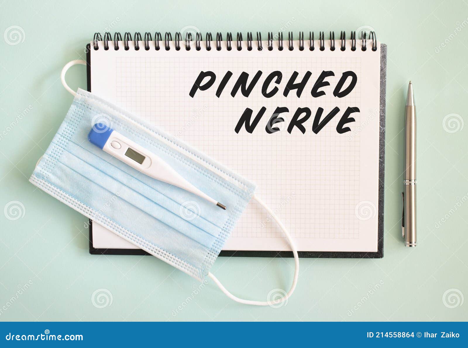 A Medical Protective Mask and a Thermometer are on the Notebook ...