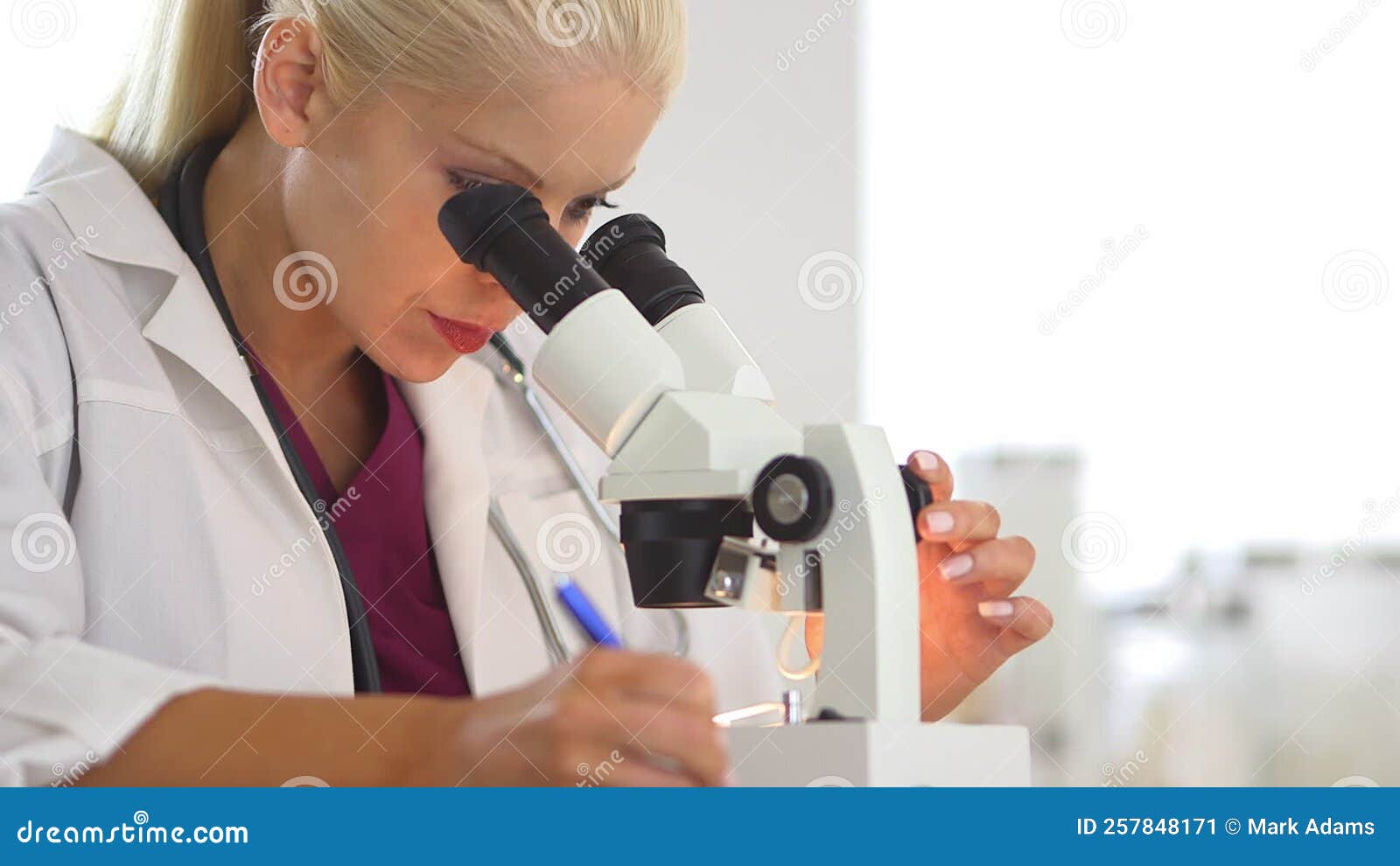 Medical Researcher Using Microscope and Writing Notes Stock Video ...