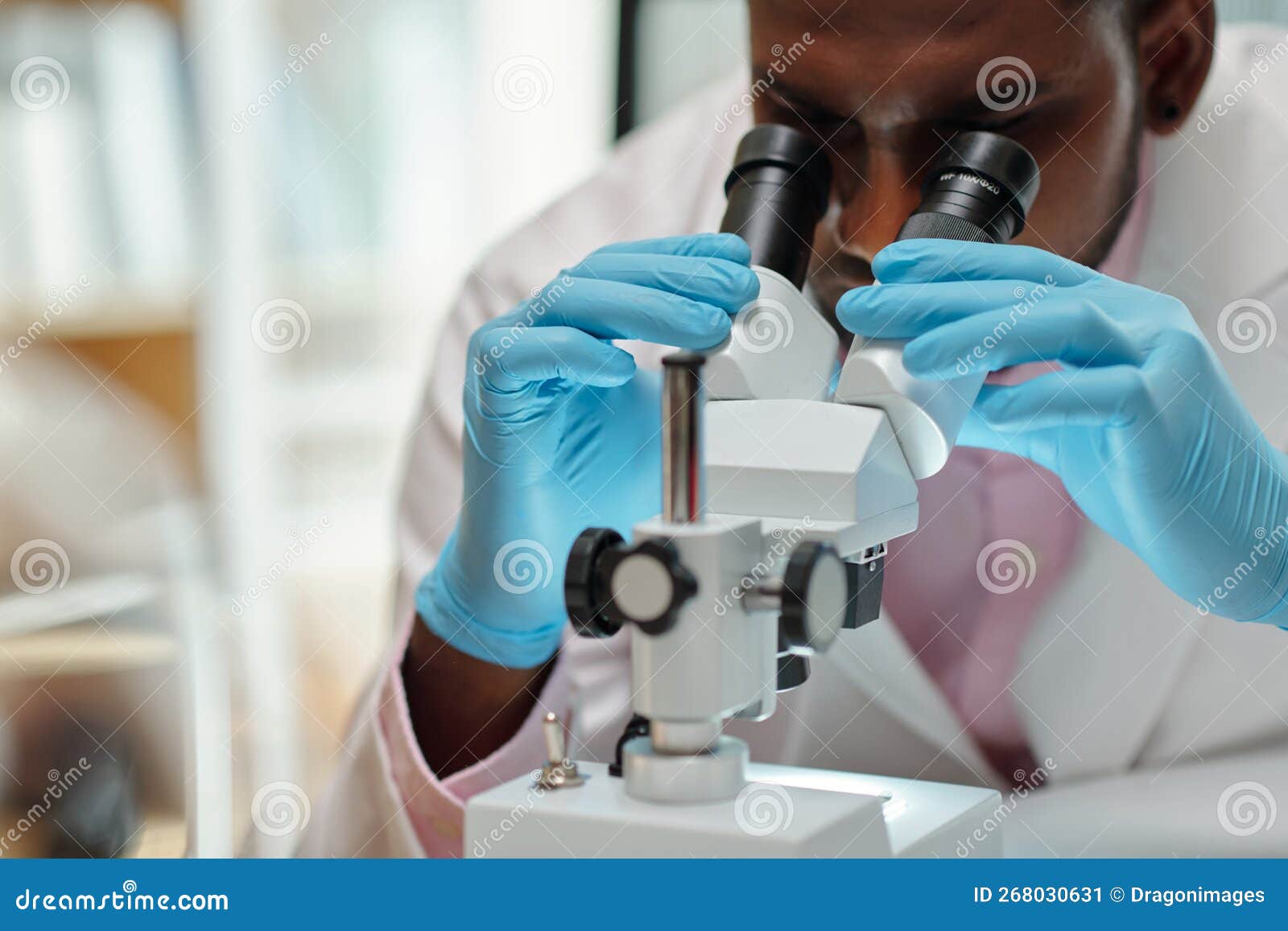 Medical Student Looking through Microscope Stock Image - Image of ...