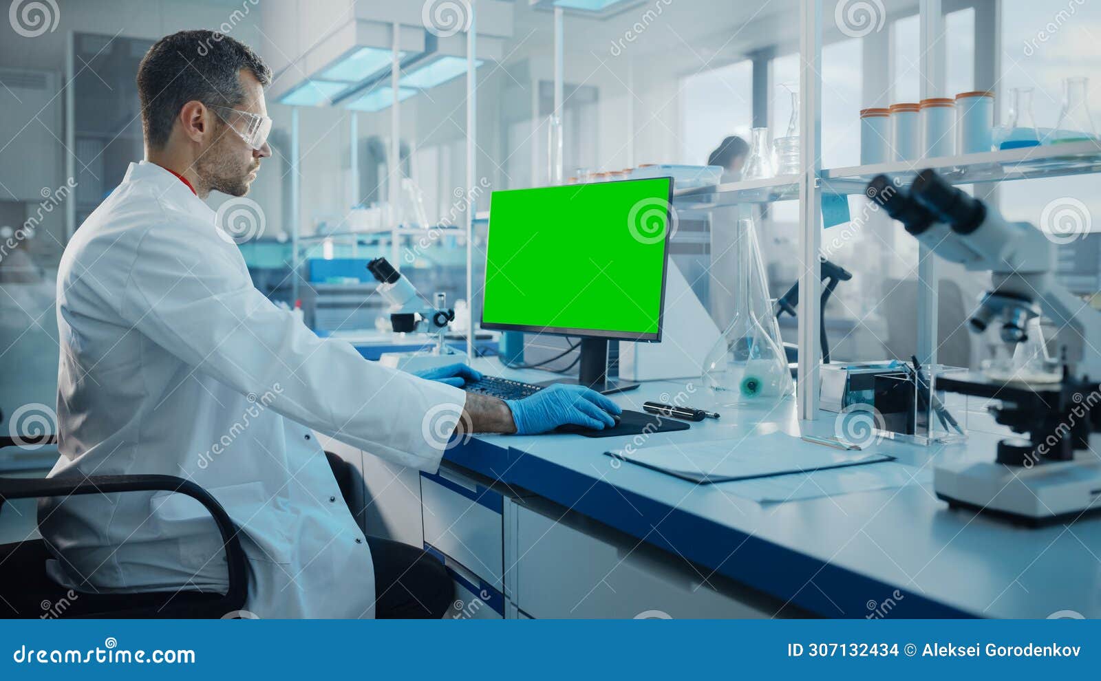 Medical Science Laboratory: Microbiologist Working on Computer with ...