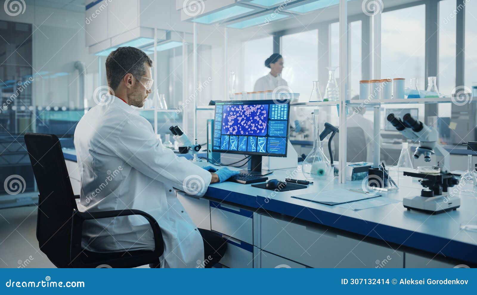 Medical Science Laboratory: Microbiologist Working on Computer with ...