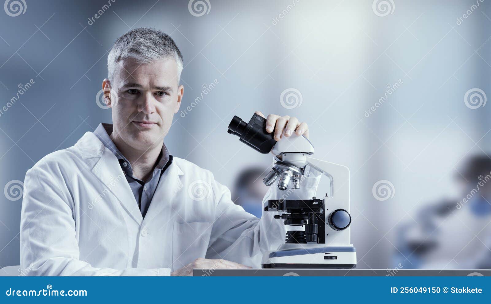 Medical Scientist Posing with a Microscope Stock Photo - Image of ...