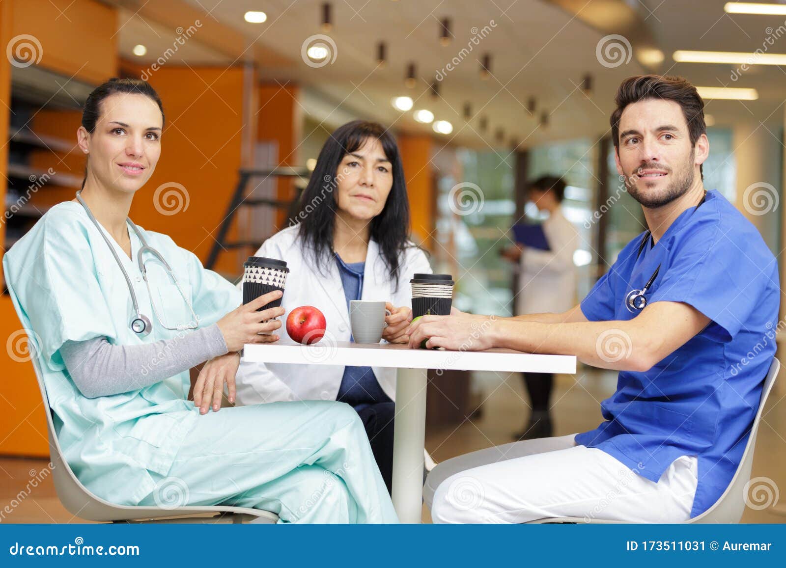 Medical Staff Sat Around Table during Break Stock Image - Image of ...