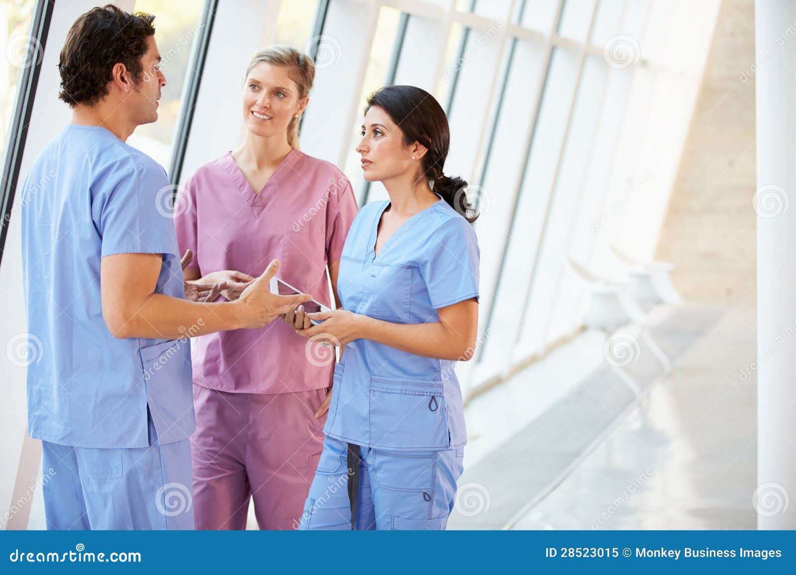 Medical Staff Talking in Hospital Corridor with Digital Tablet Stock ...