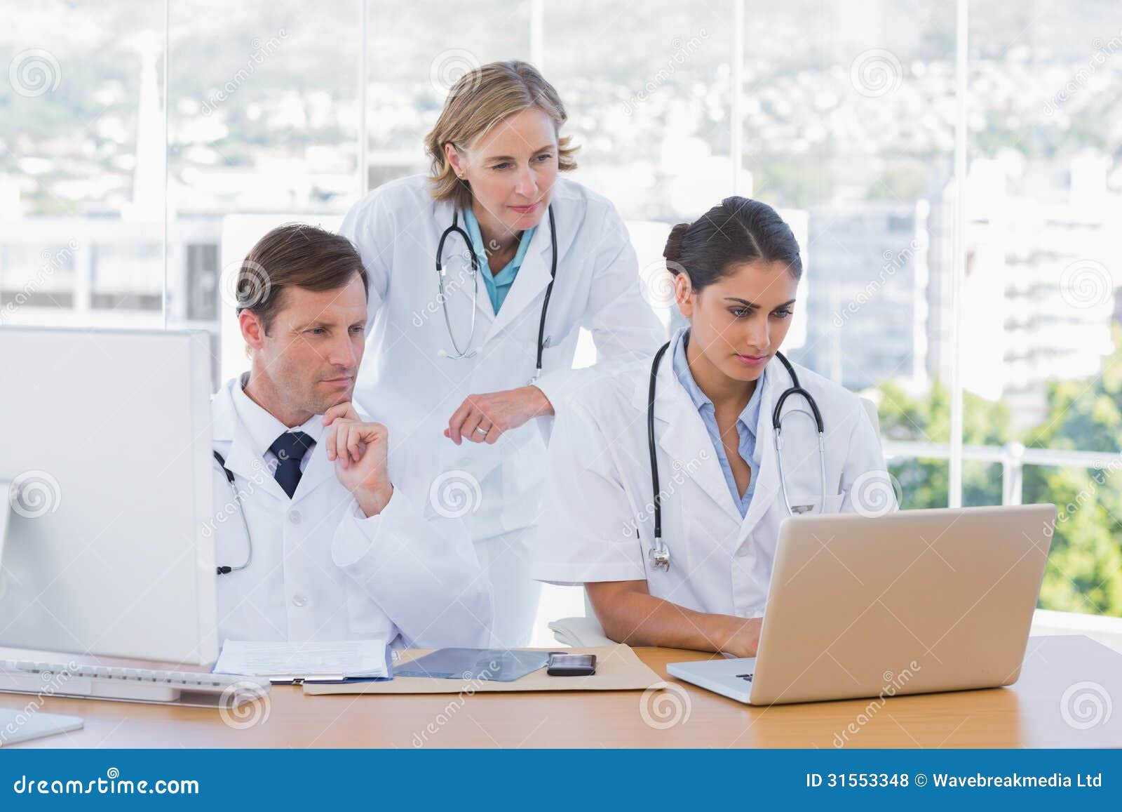 Medical Staff Working Together on a Laptop and a Computer Stock Photo ...