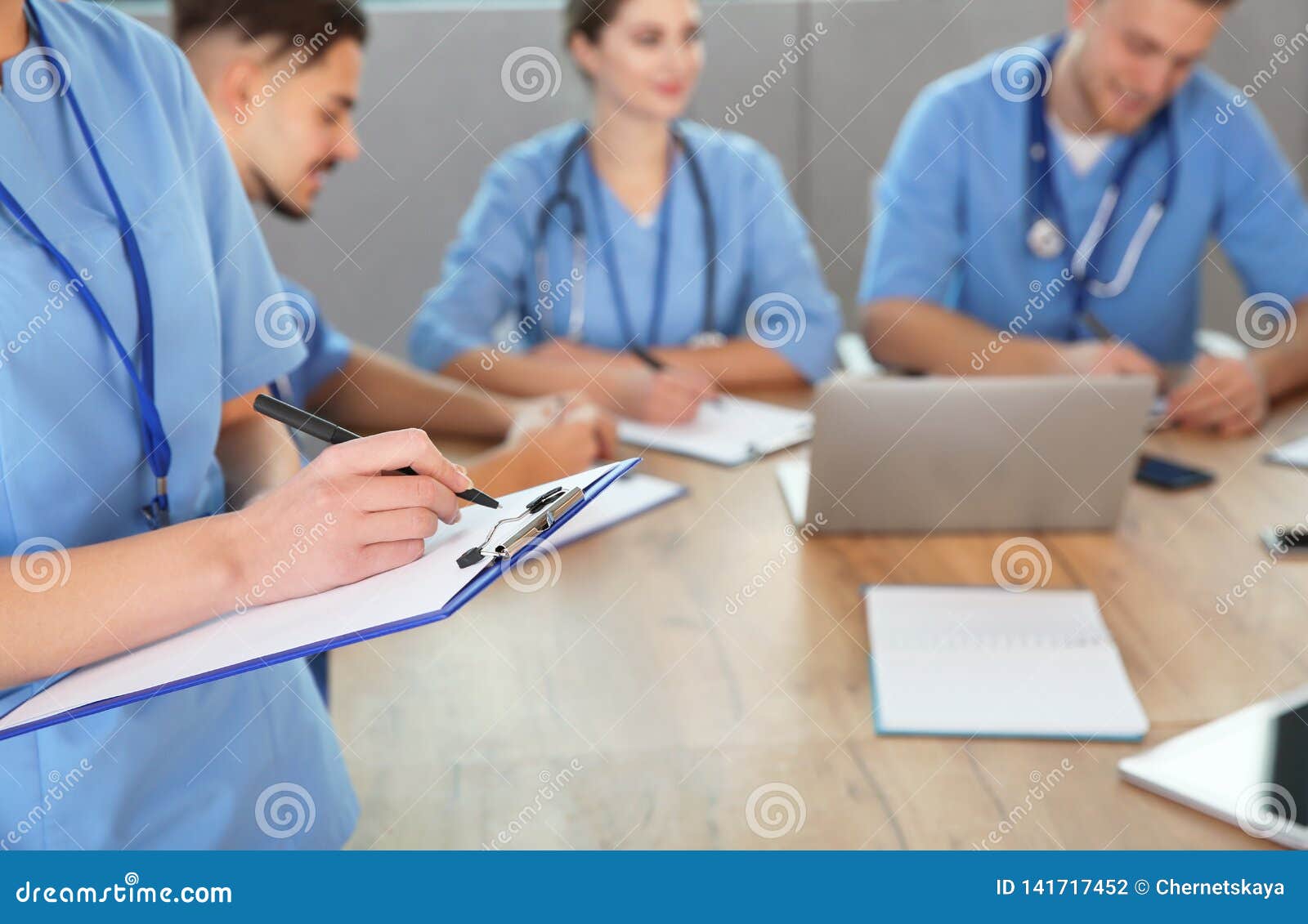 Medical Student with Clipboard and Her Groupmates Studying in ...