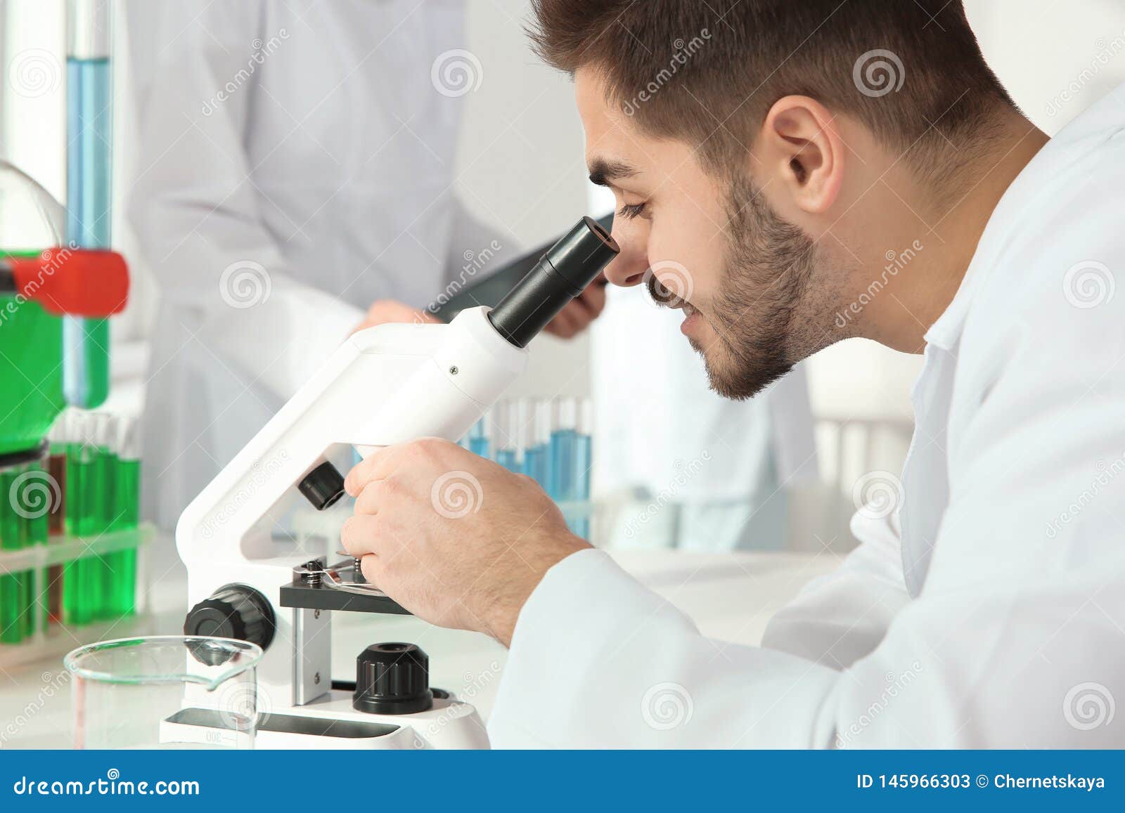 Medical Student Working with Microscope in Scientific Laboratory Stock ...