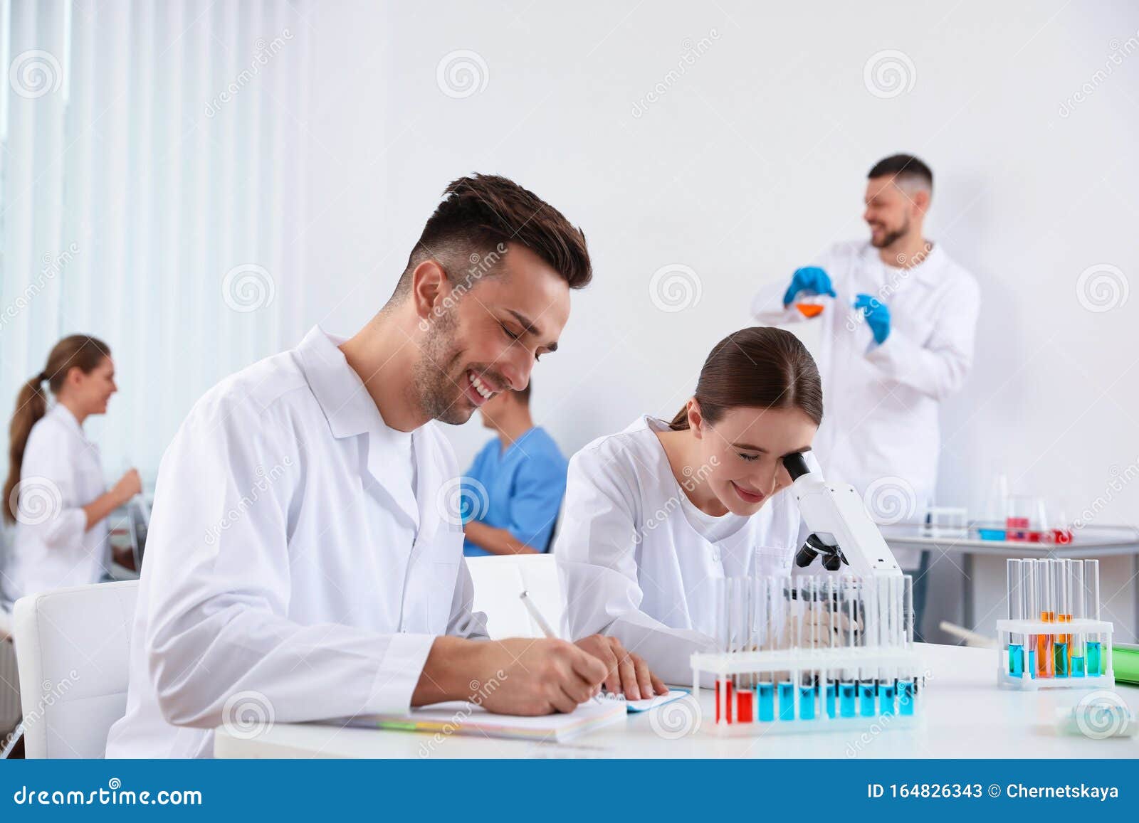 Medical Students with Microscope in Laboratory Stock Image - Image of ...