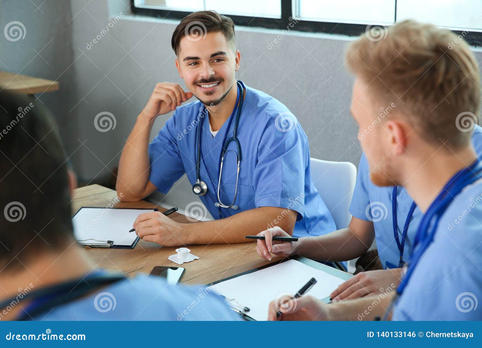 Medical Students in Uniforms Studying Stock Photo - Image of intern ...