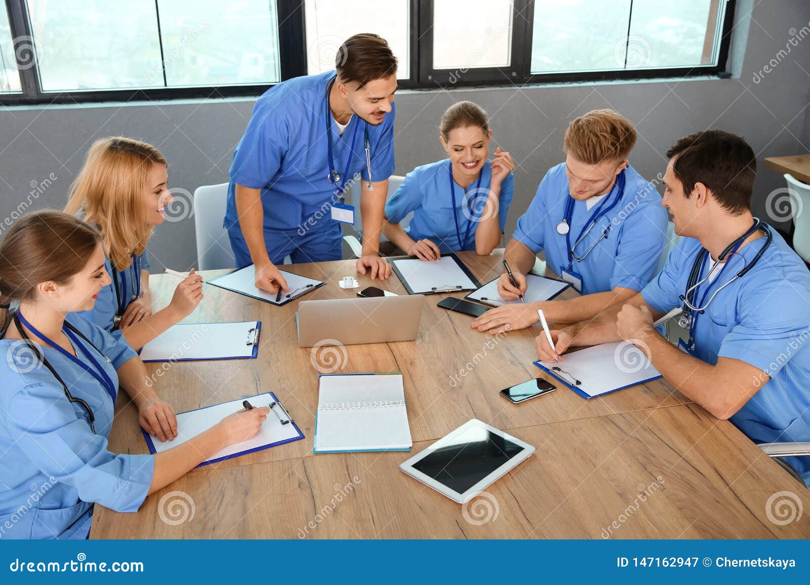 Medical Students in Uniforms Studying Stock Image - Image of medical ...