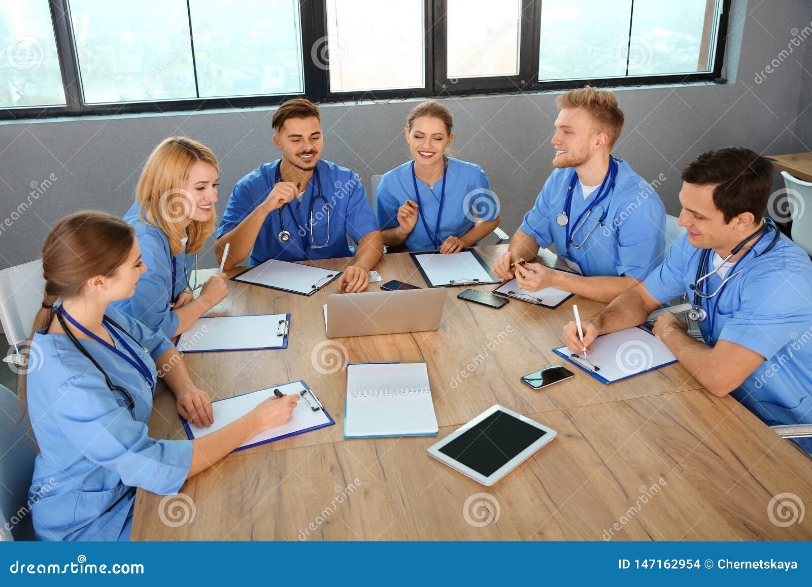 Medical Students in Uniforms Studying Stock Photo - Image of laptop ...