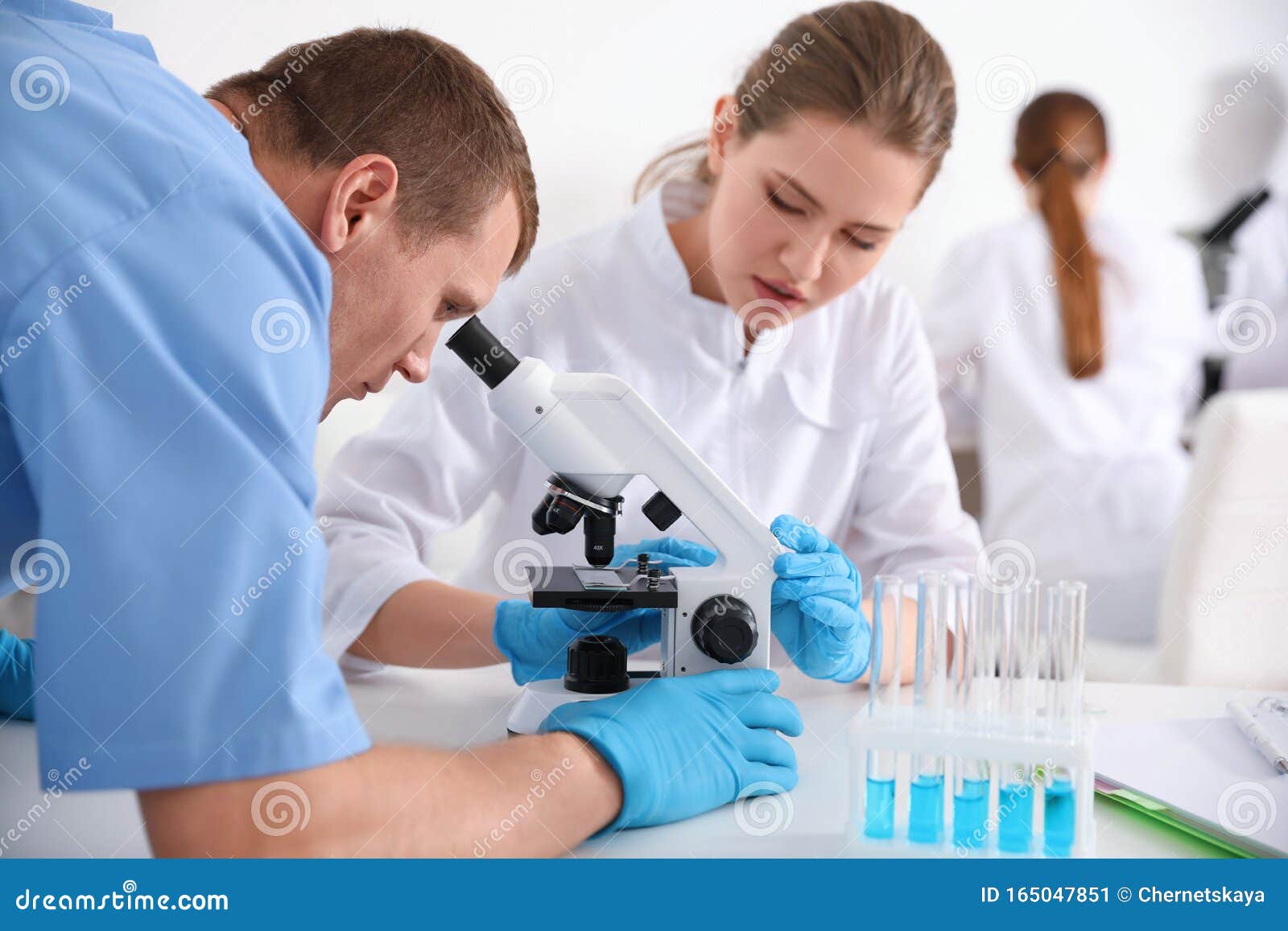 Medical Students Working with Microscope in Laboratory Stock Image ...