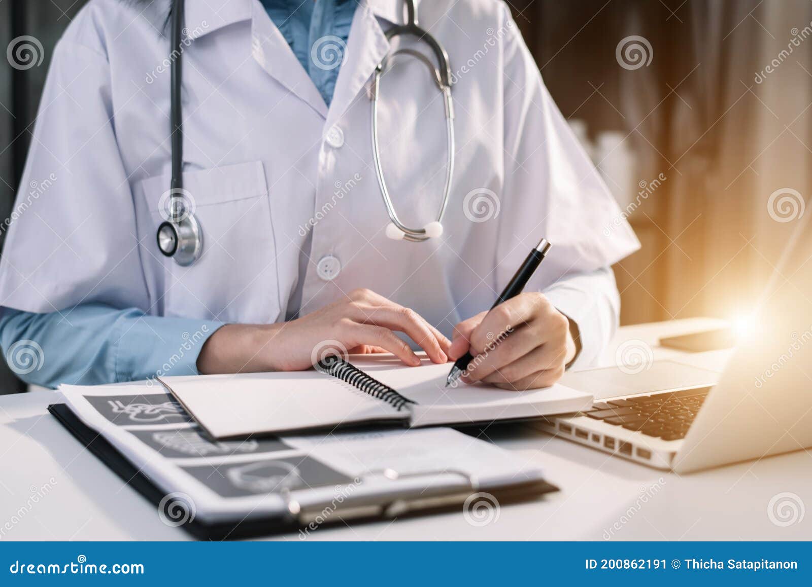 Medical Students Write in a Notebook and Work on Their Laptop Computers ...