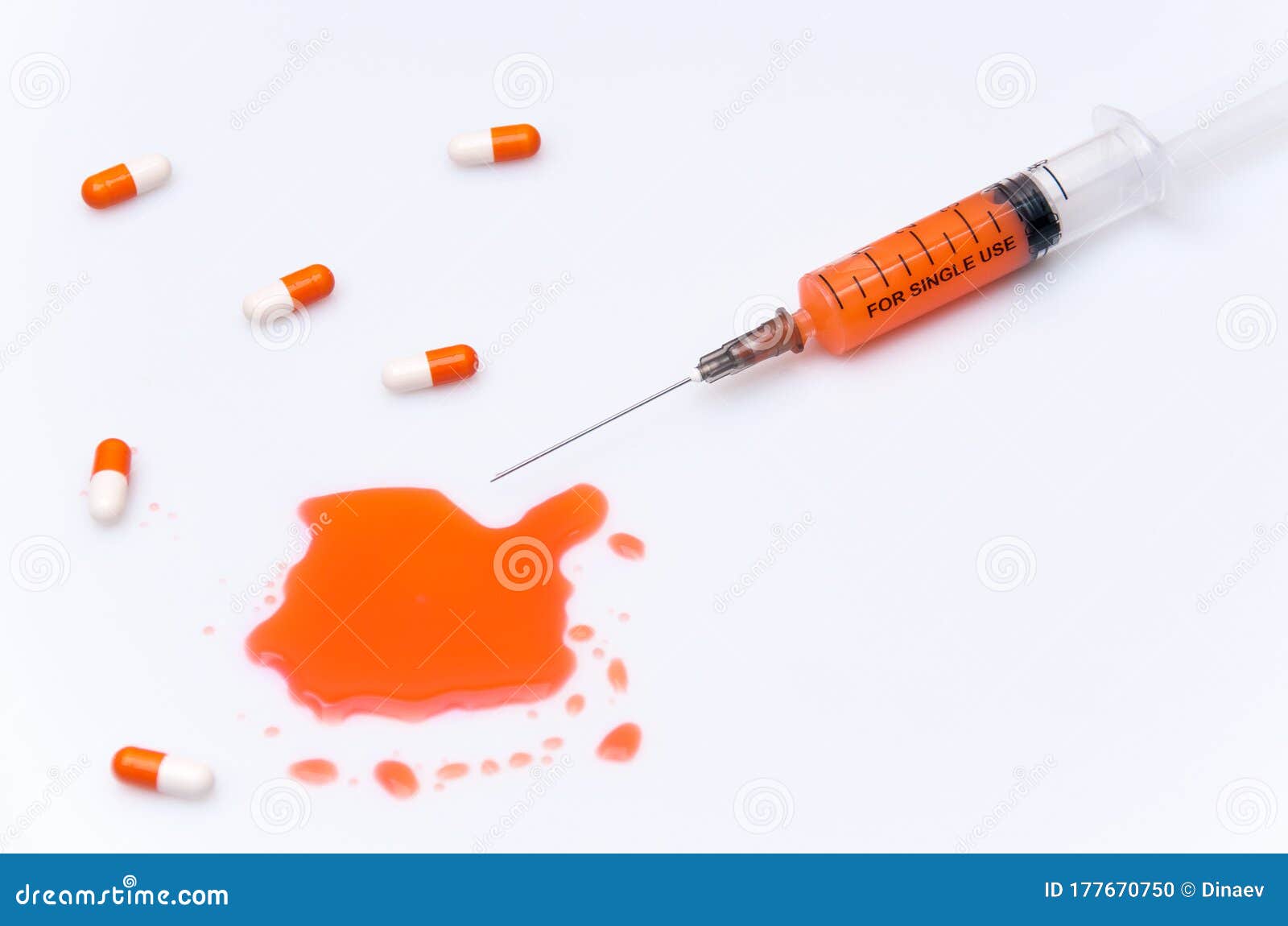 A Medical Syringe with a Orange Solution Lies on a White Background ...