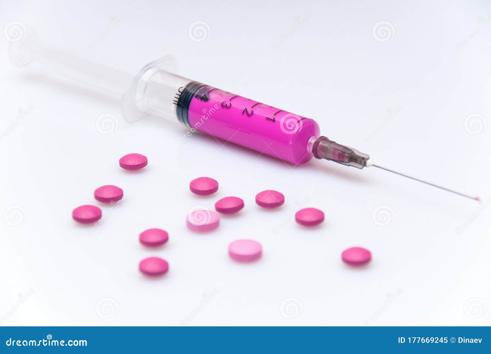 A Medical Syringe with a Purple Solution Lies on a White Background ...