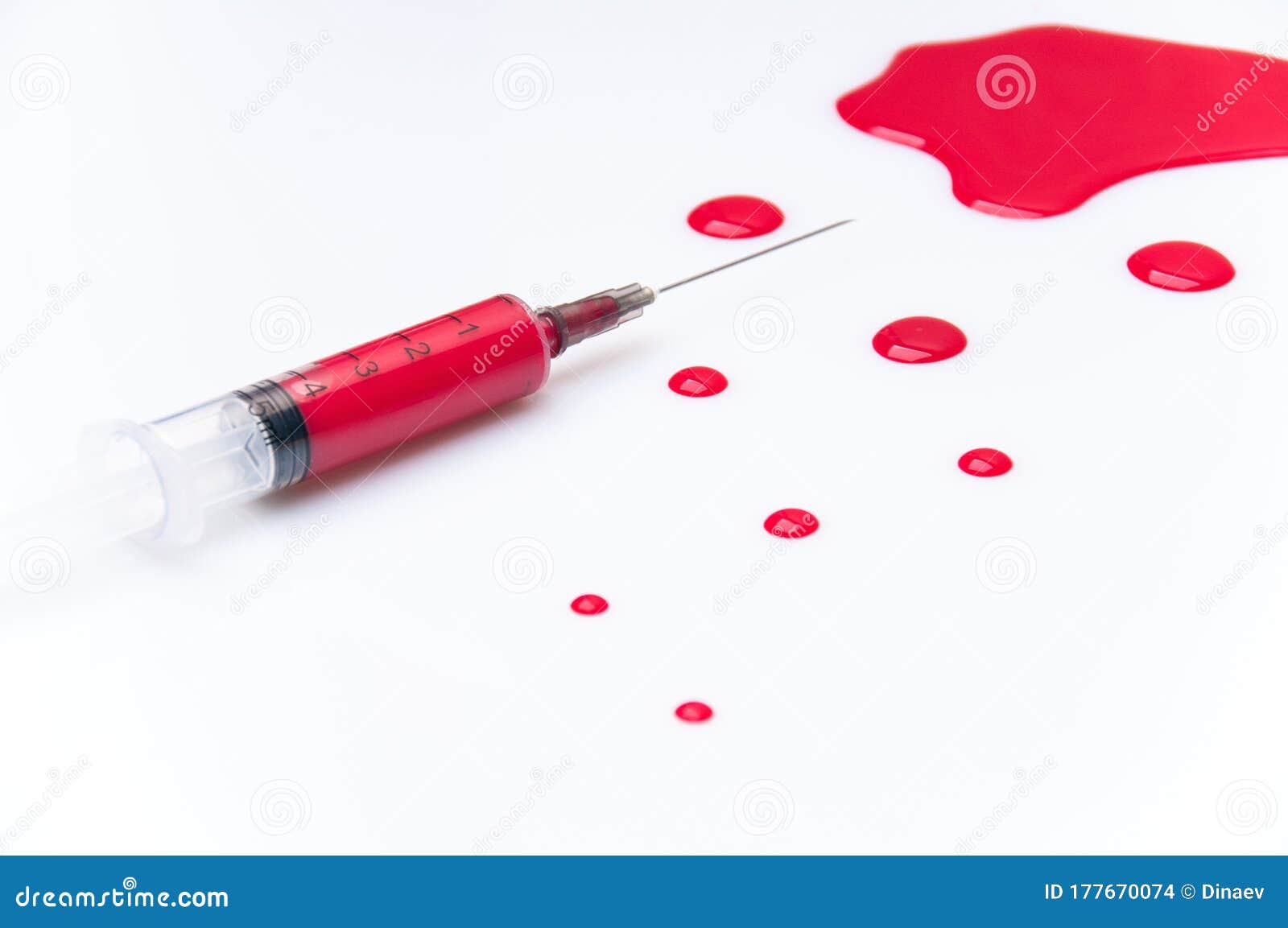Medical Syringe with Red Blood on a White Background Surrounded by ...