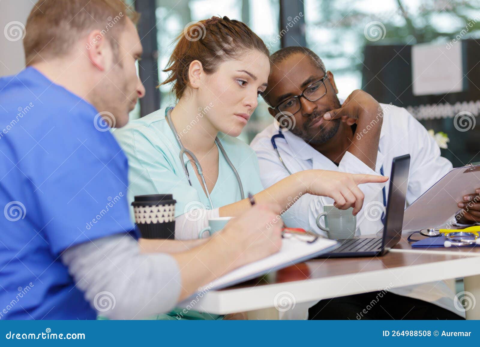 Medical Team Discussing Ideas Using Computer Stock Photo - Image of ...