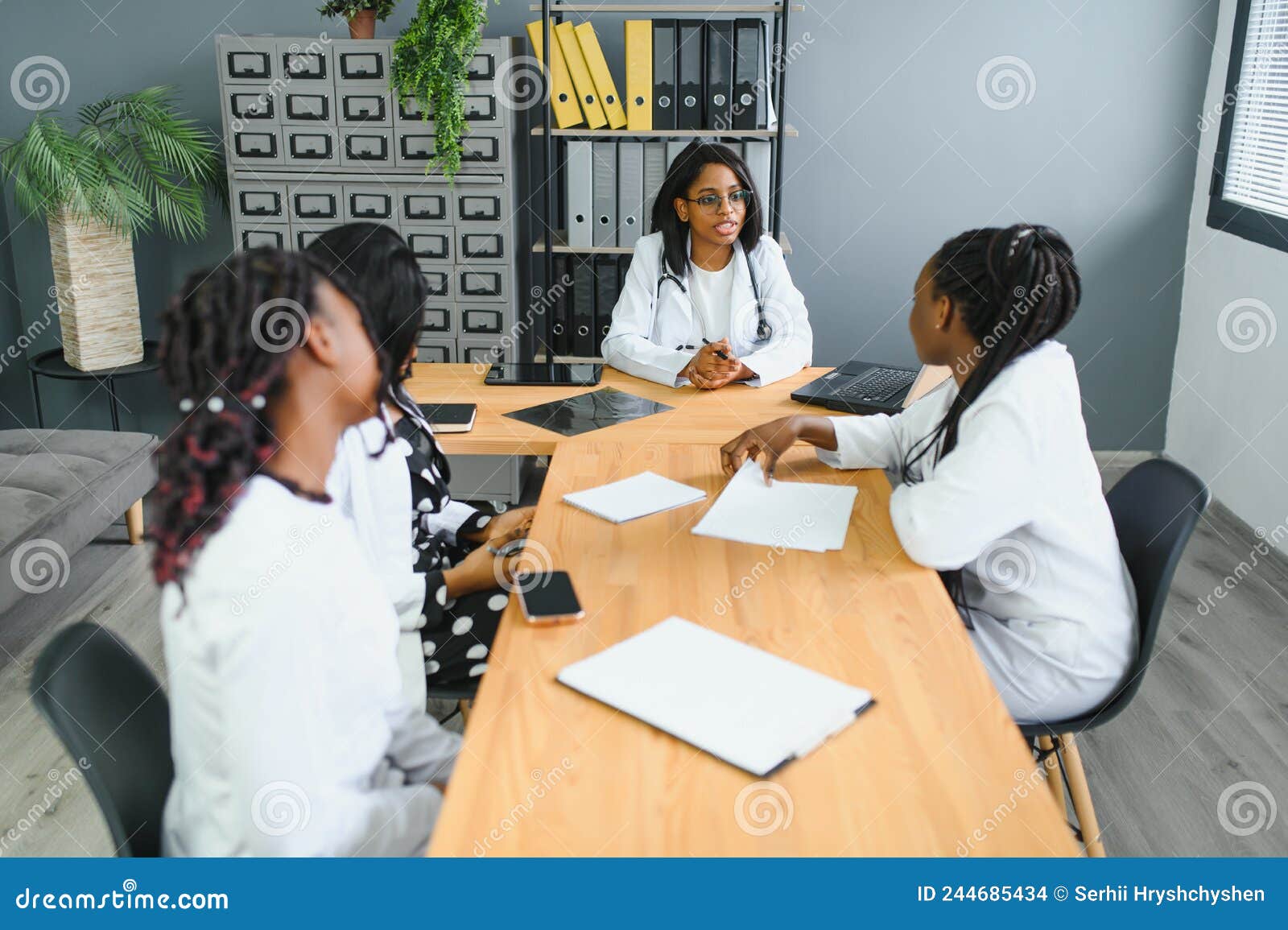 Medical Team Discussing Treatment Options with Patients. Stock Photo ...