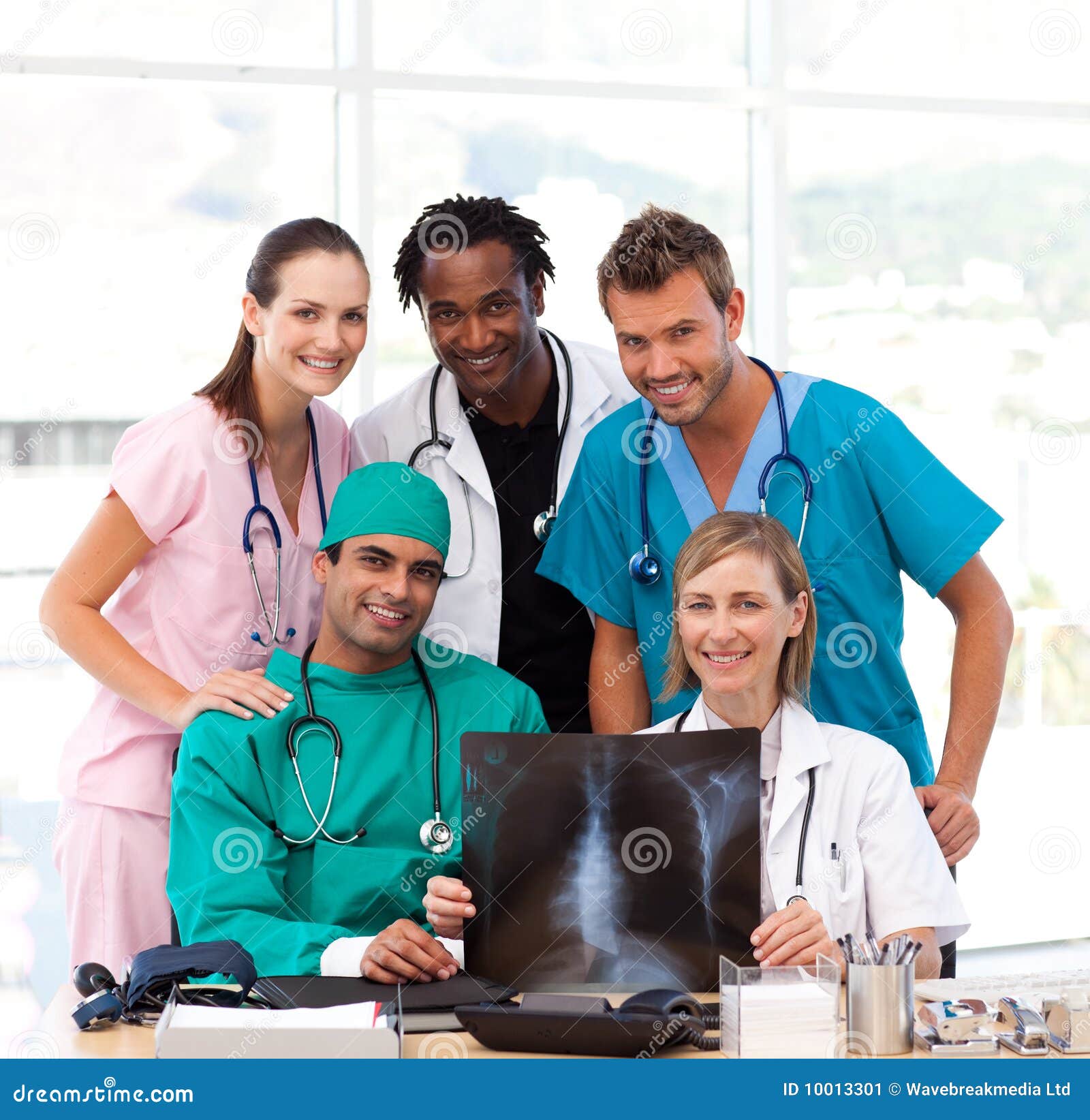 Medical Team Examining an X-ray and Smiling Stock Image - Image of ...