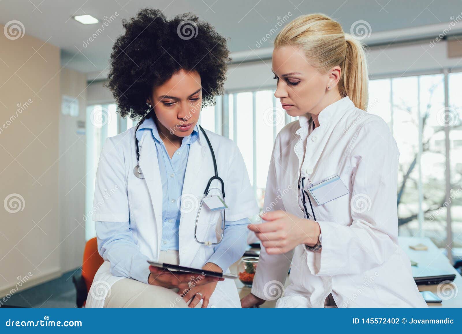 Medical Team Sitting and Discussing at the Table Stock Photo - Image of ...