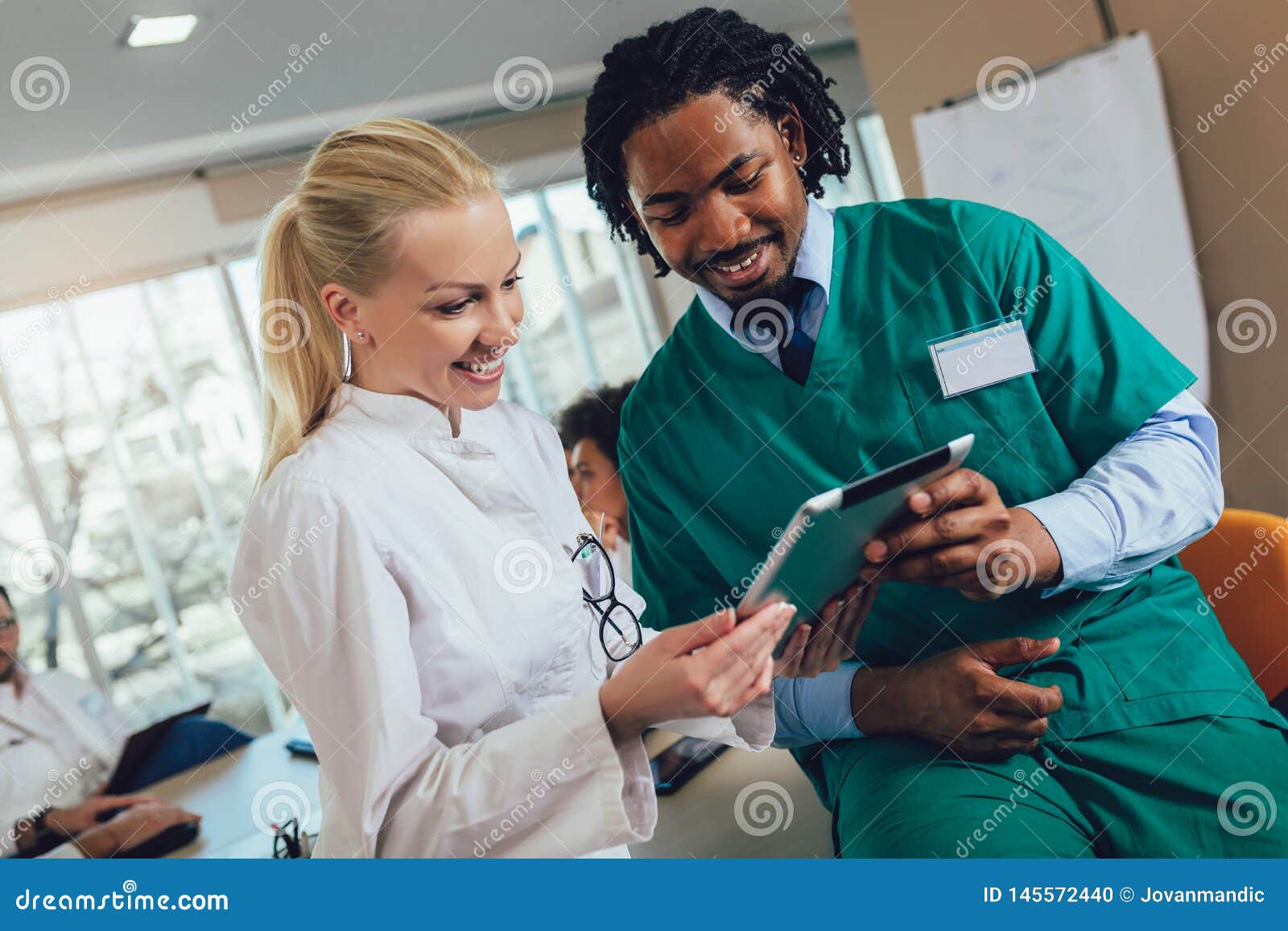 Medical Team Sitting and Discussing at the Table Stock Photo - Image of ...