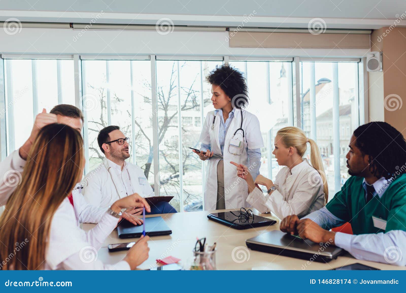 Medical Team Sitting and Discussing at the Table Stock Photo - Image of ...