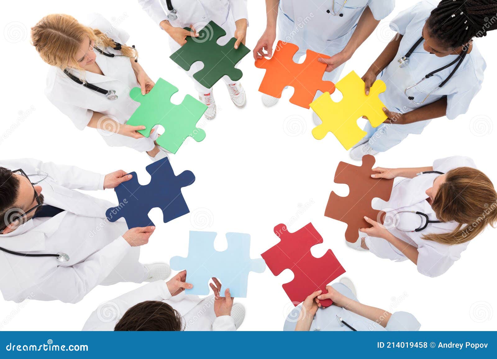 Medical Team Solving Jigsaw Puzzle Stock Photo - Image of group, green ...