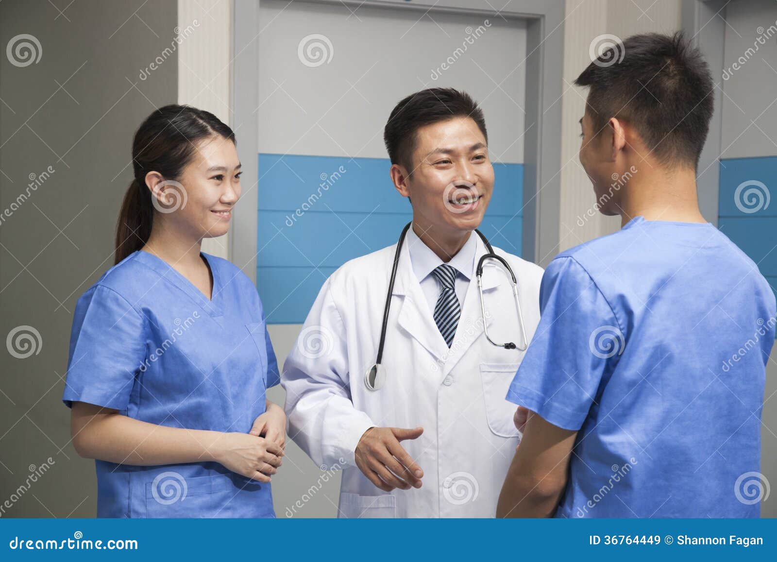 Medical Team Talking in Hospital Stock Image - Image of black, indoors ...
