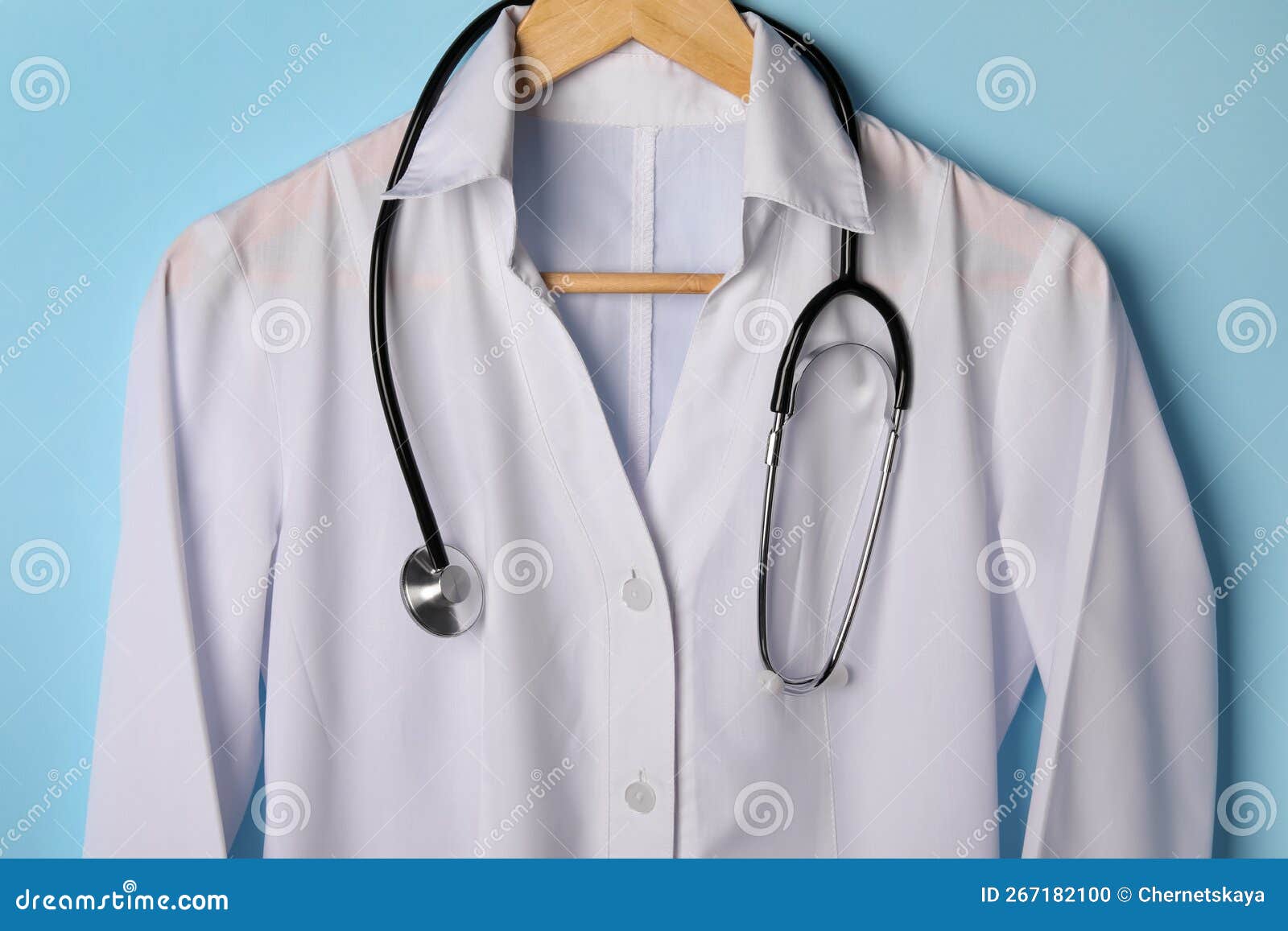 Medical Uniform and Stethoscope on Light Blue Background Stock Photo ...