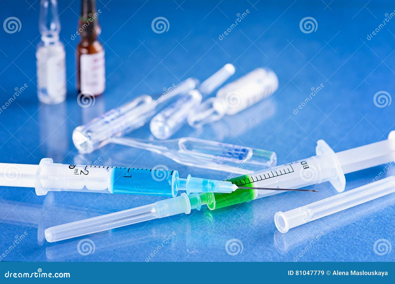 Medical Vials for Injection with a Syringe Isolated on Blue Background ...